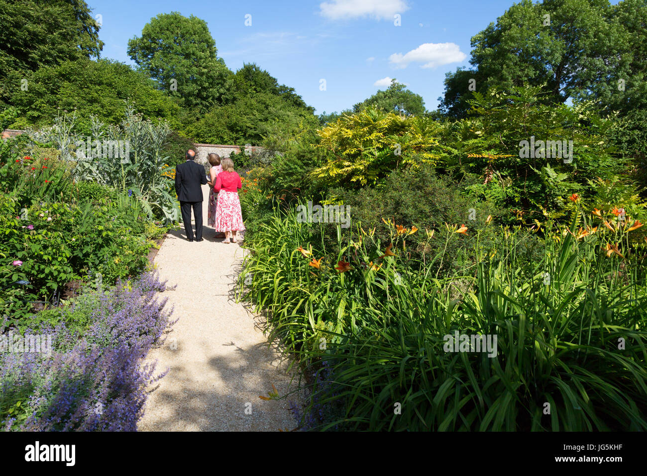 Opera goers at Garsington Opera walk in the gardens of Wormsley Park ...