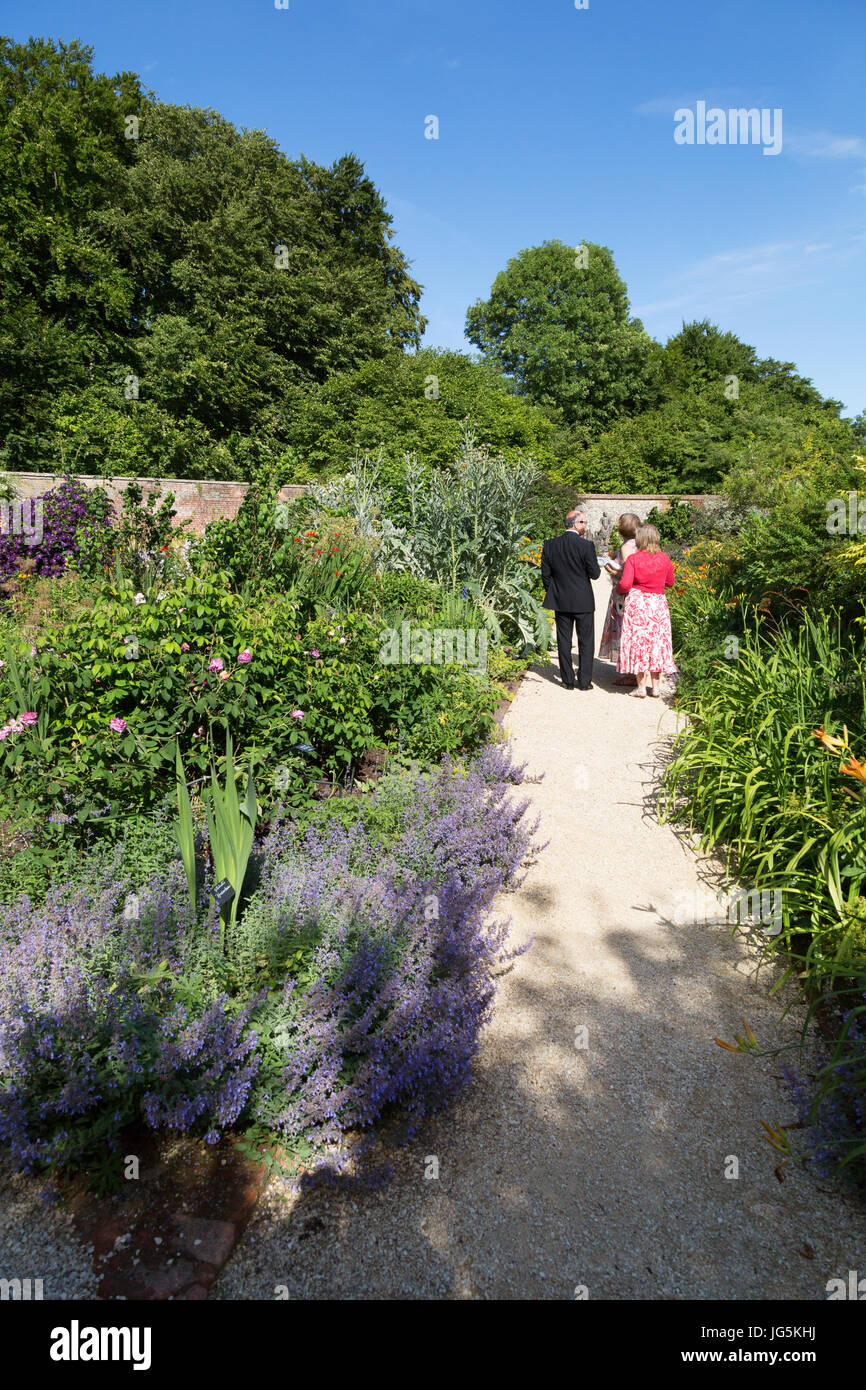 Opera goers at Garsington Opera walk in the gardens of Wormsley Park ...