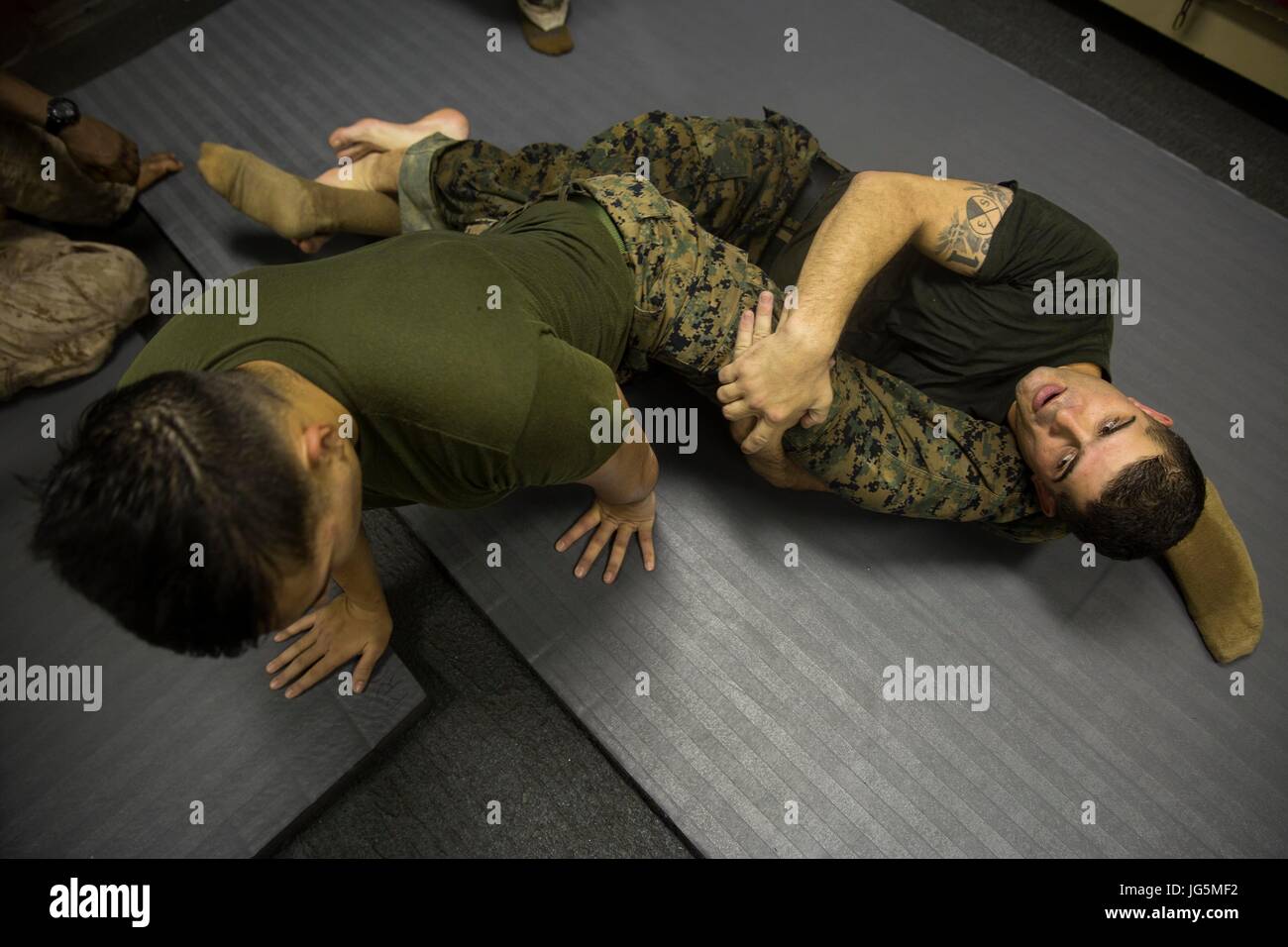 A Marine Corps Martial Arts Program instructor conducts MCMAP training ...