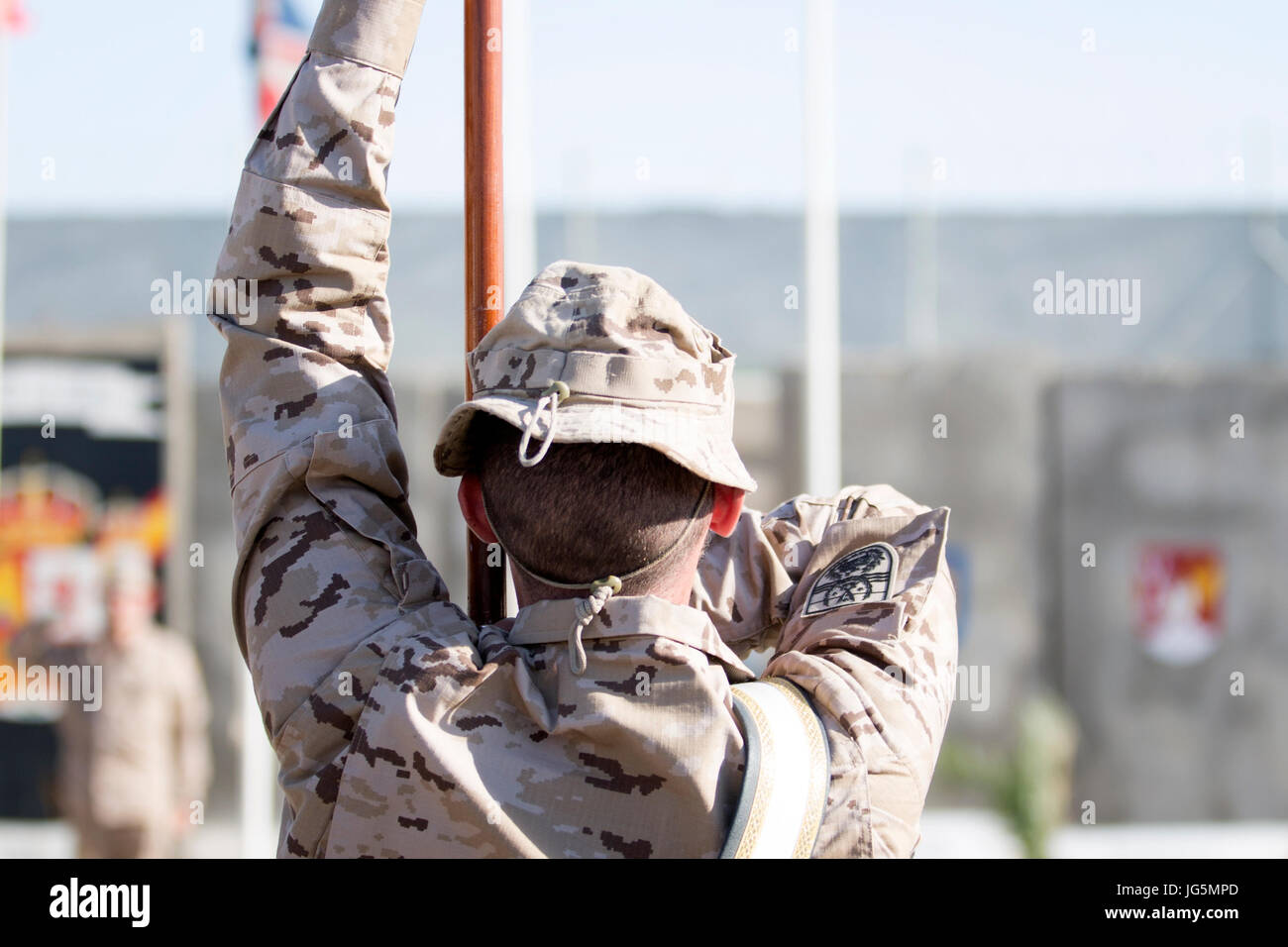 A Spanish army soldier holds a flag at attention during a ceremony held ...