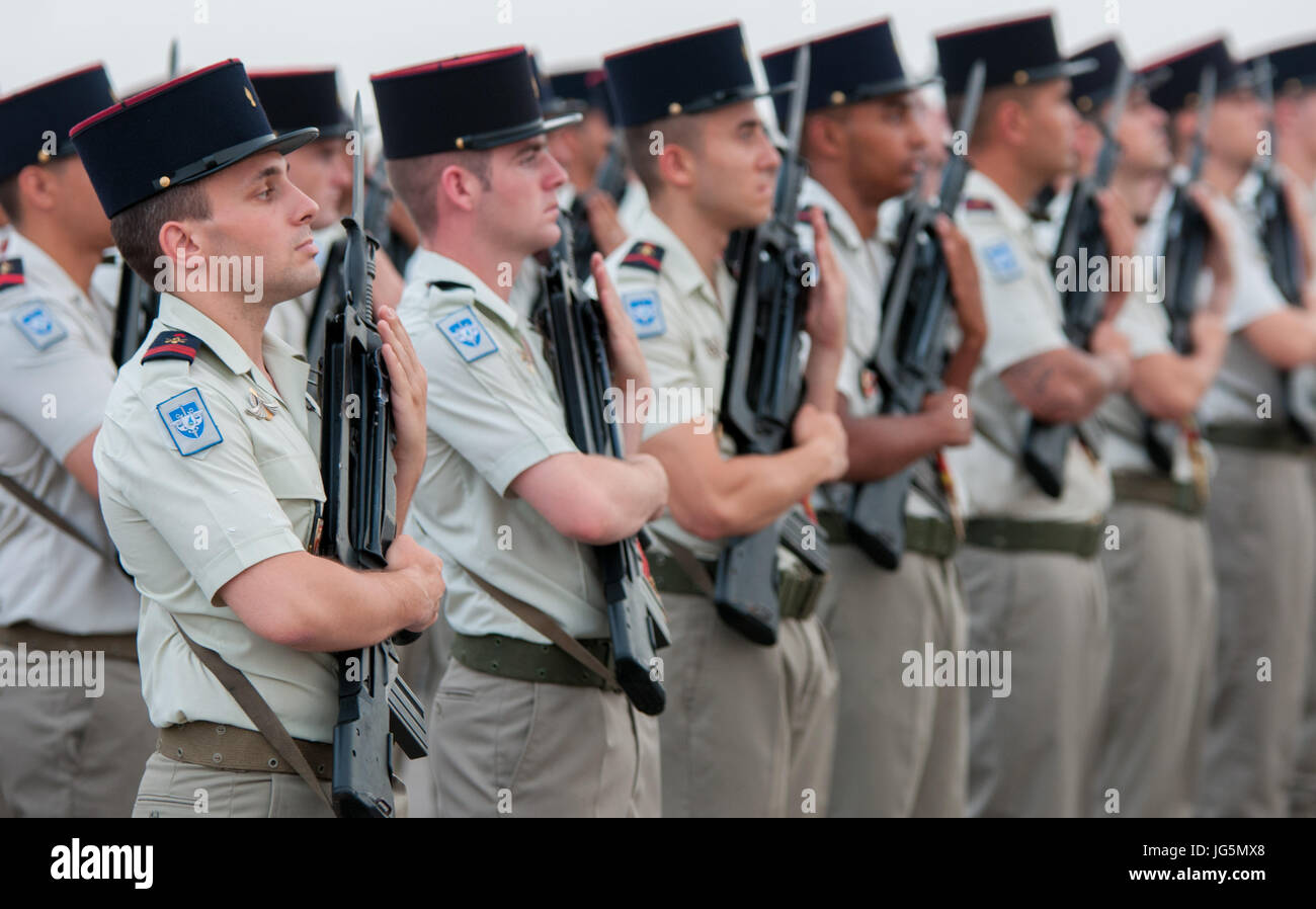 French service members stand at attention during the Independence Day ...