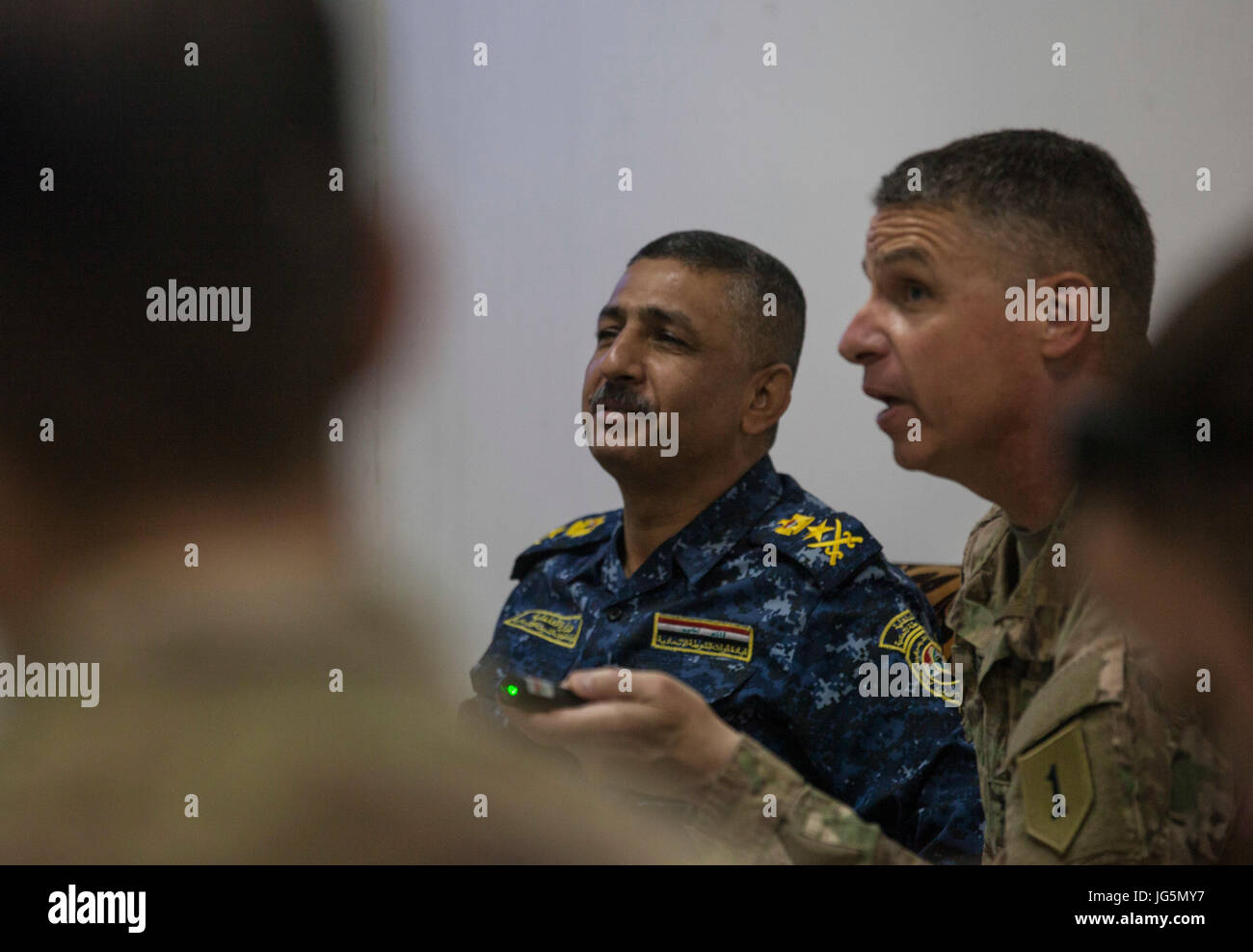 A Federal Police official listens to U.S. Army Maj. Gen. Joseph Martin ...
