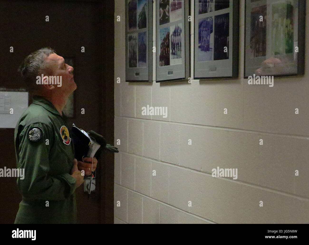 Lt. Gen. Jon Davis, looks at the photos of previous pilot instructors ...