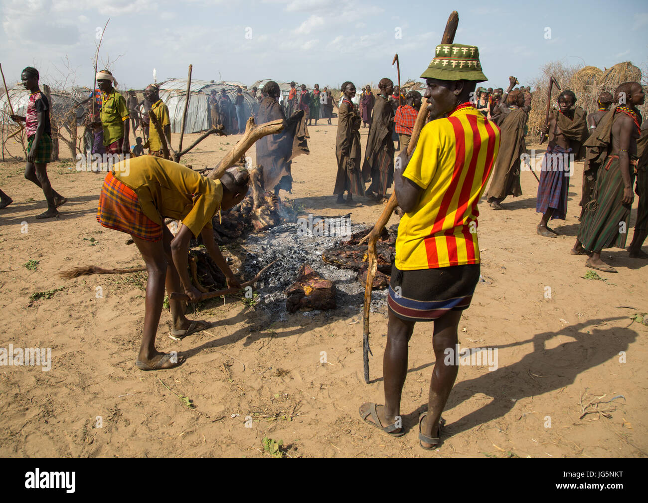 Tribe people cooking a cowduring the proud ox ceremony in the Dassanech ...