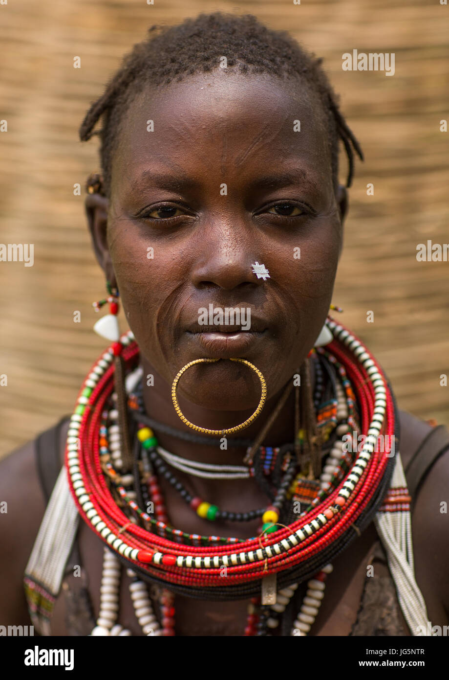 Portrait of a sudanese Toposa tribe woman refugee with huge necklaces ...