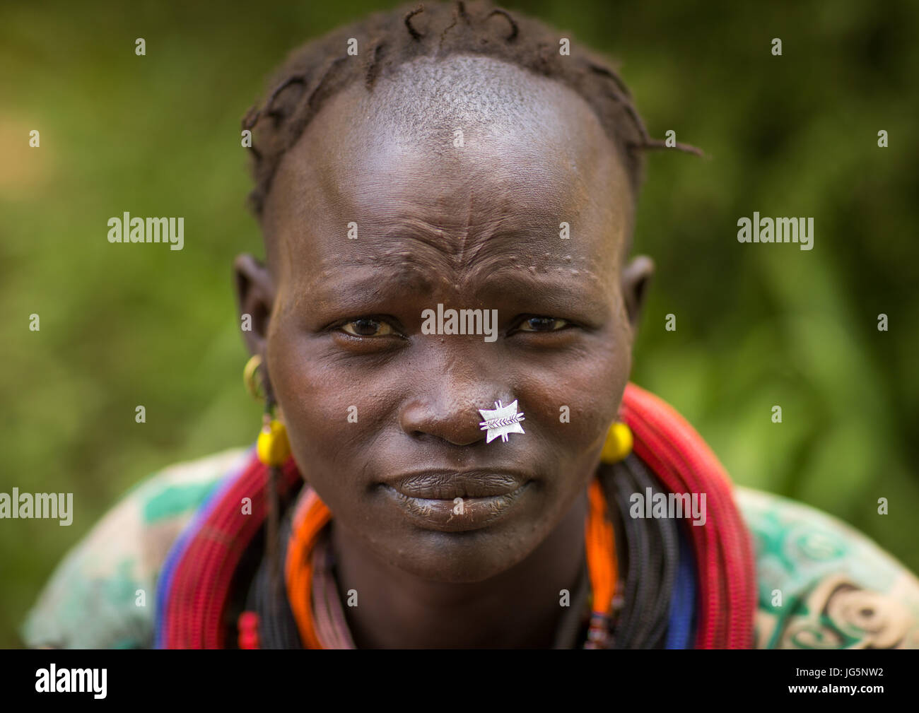 Portrait of a sudanese Toposa tribe woman refugee with nose decoration ...