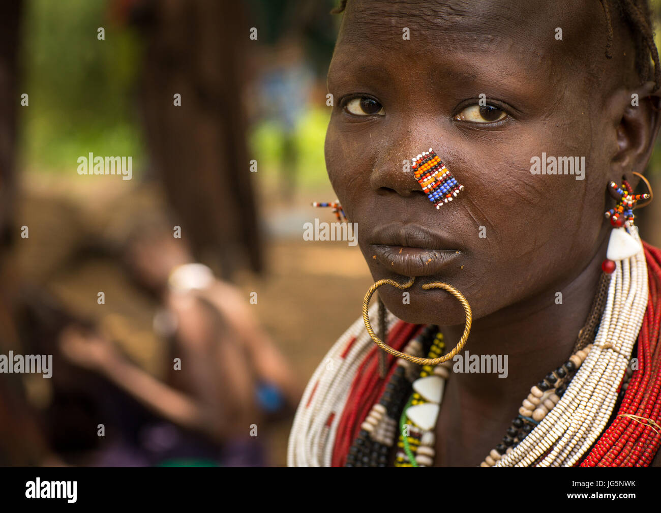 Portrait of a sudanese Toposa tribe woman refugee with nose decoration ...