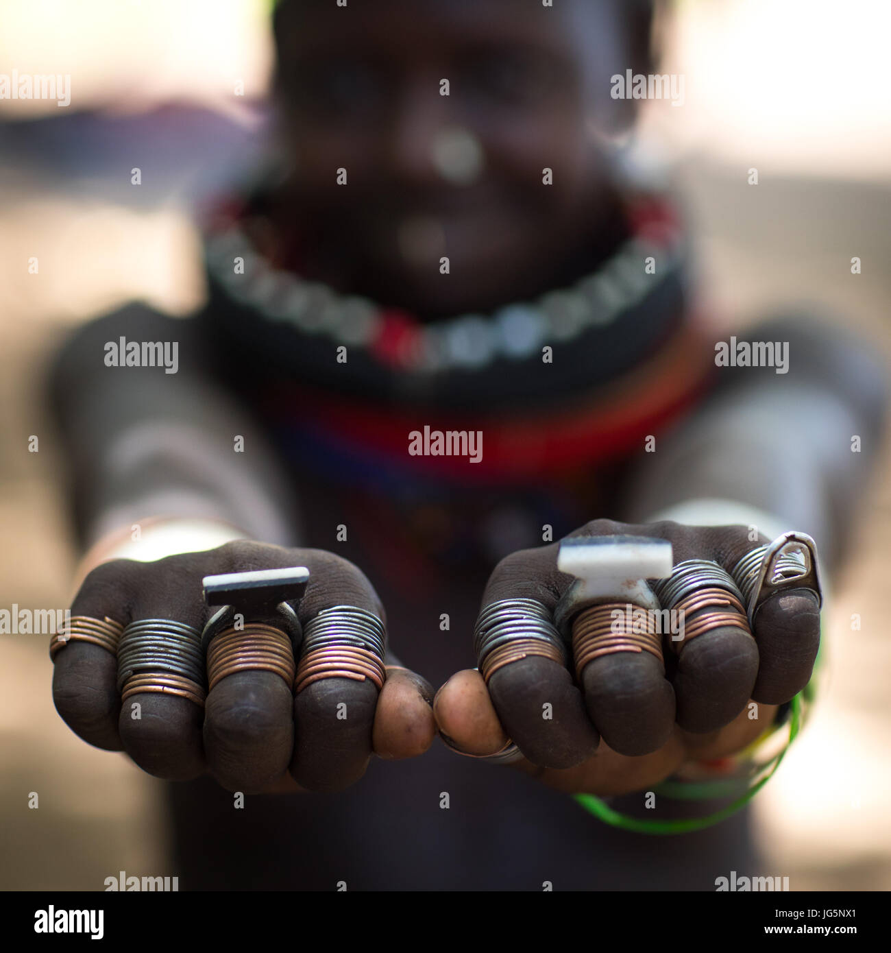 Sudanese Toposa tribe girl refugee showing her hand rings, Omo Valley ...