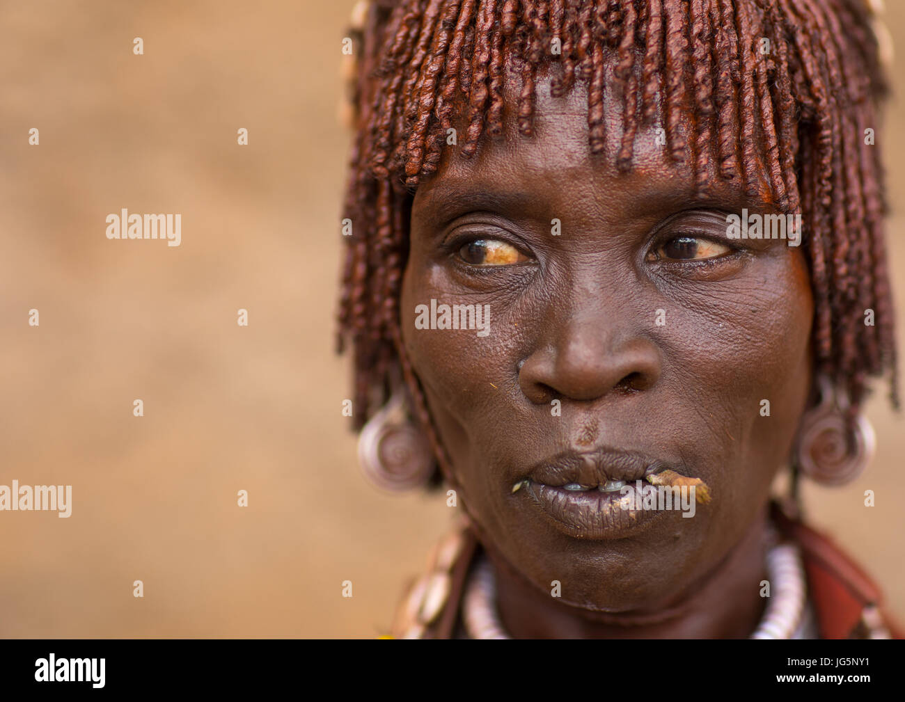 Portrait of a Hamer tribe woman with iron necklaces and stranded hair ...