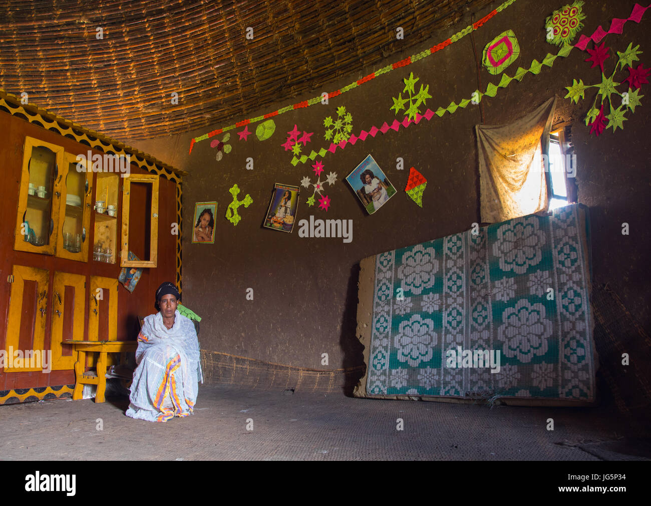 Gurage woman inside her traditional house decorated with doilies on the ...