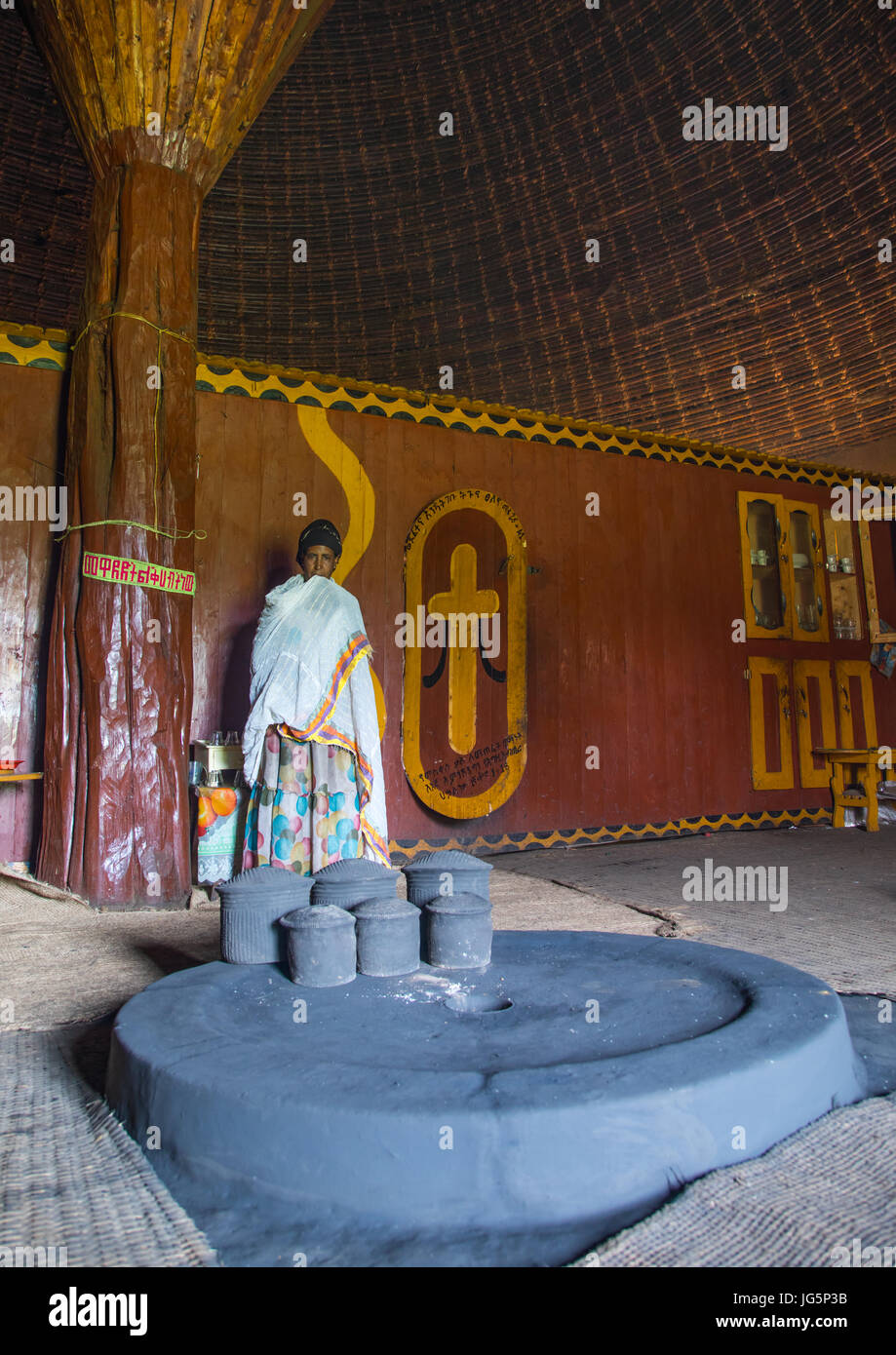 Gurage woman in front of the fireplace inside her traditional house ...