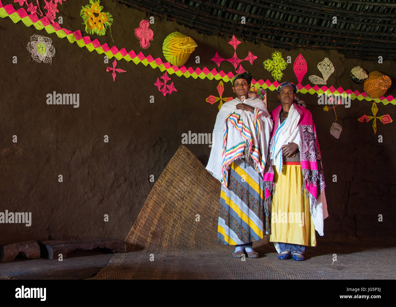 Portrait of Gurage women inside their traditional house decorated with ...