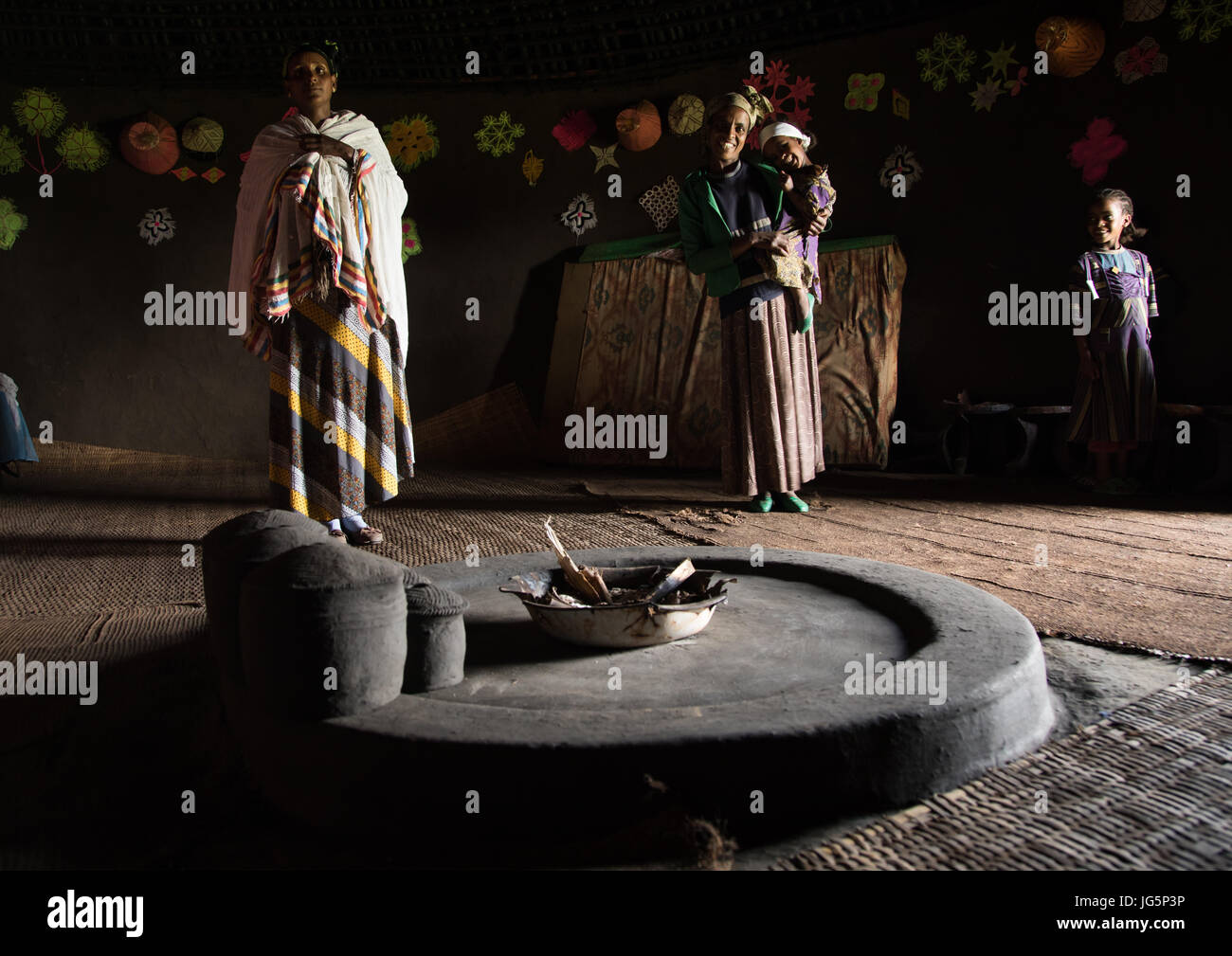 Gurage family inside their traditional house decorated with doilies on ...