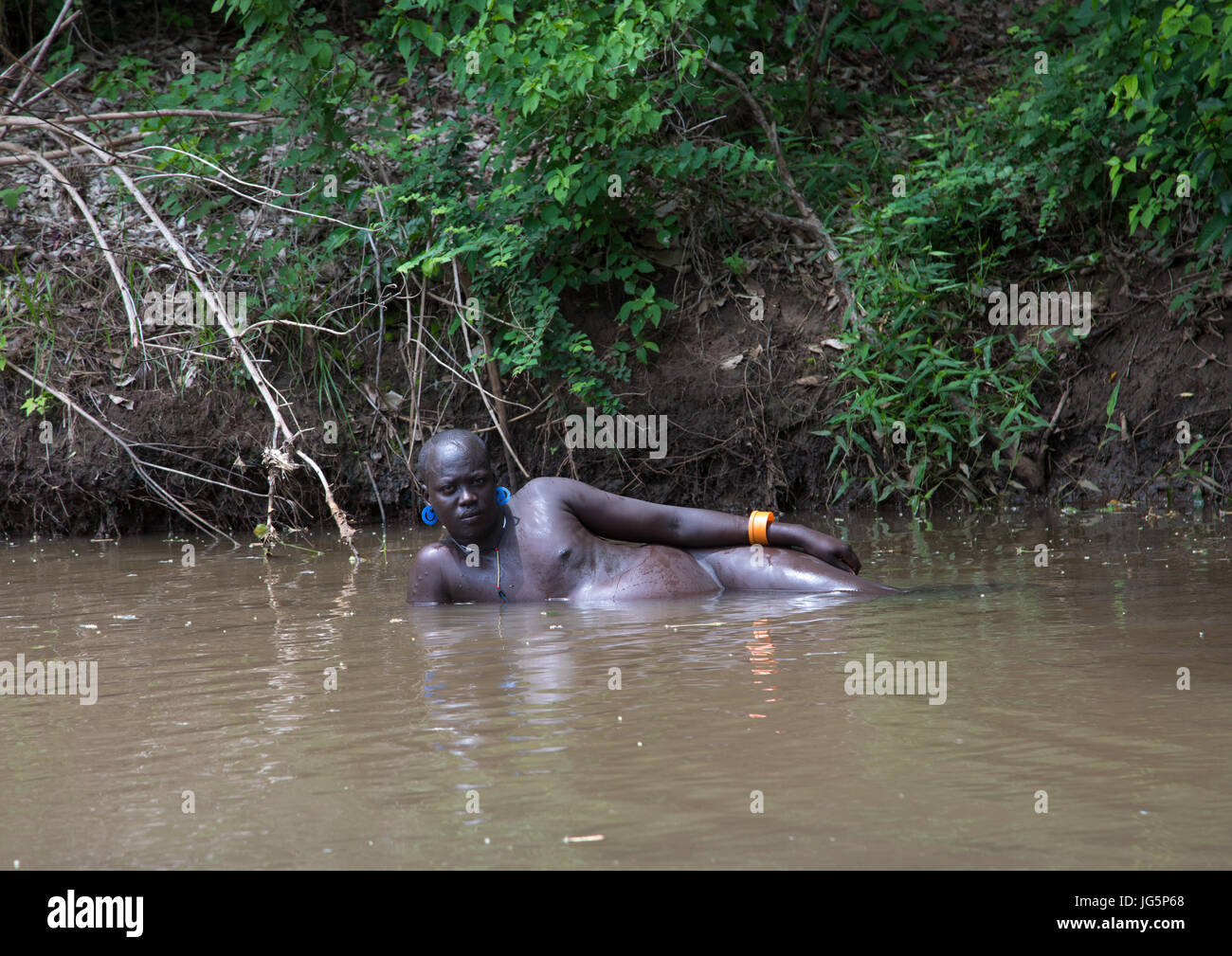 Bodi tribe fat man taking a bath before the Kael ceremony, Omo valley ...