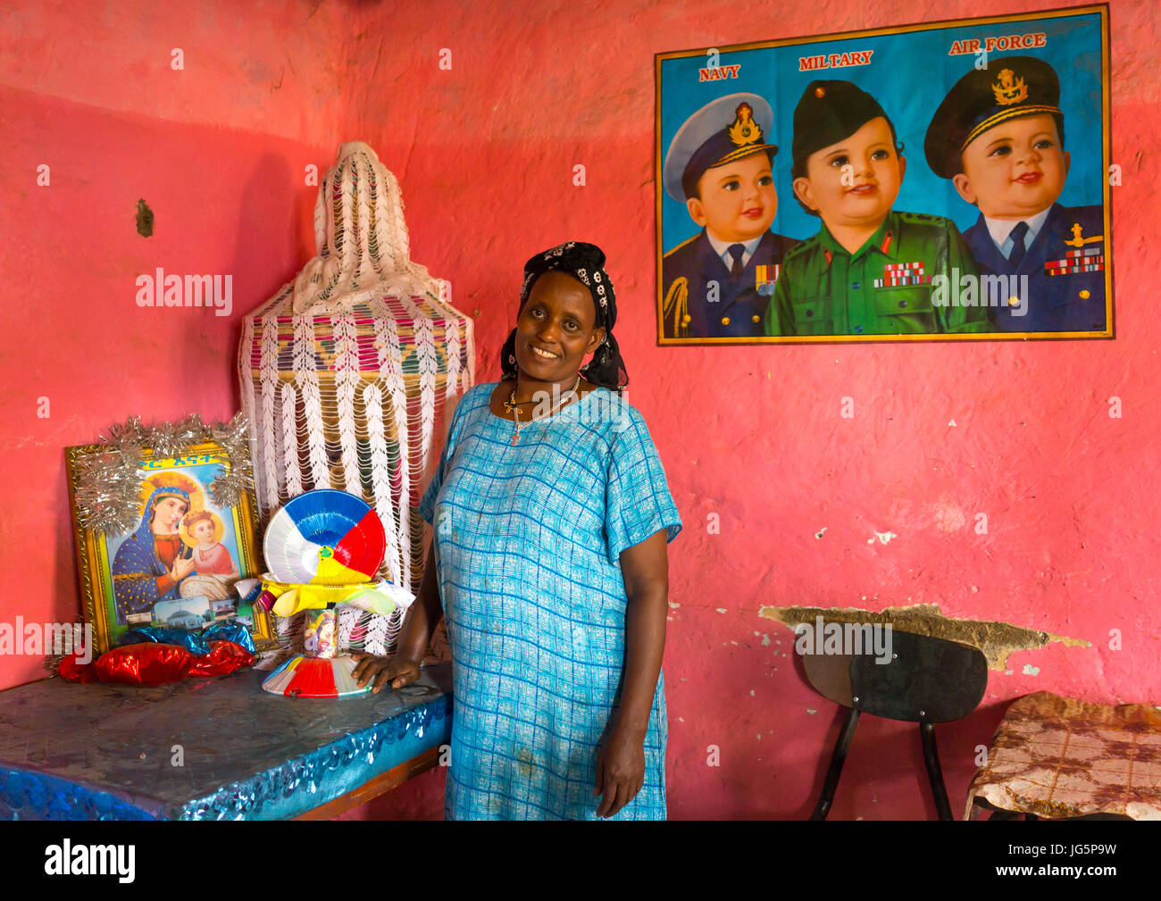 Ethiopian woman in her house decorated with a chinese poster, Omo ...