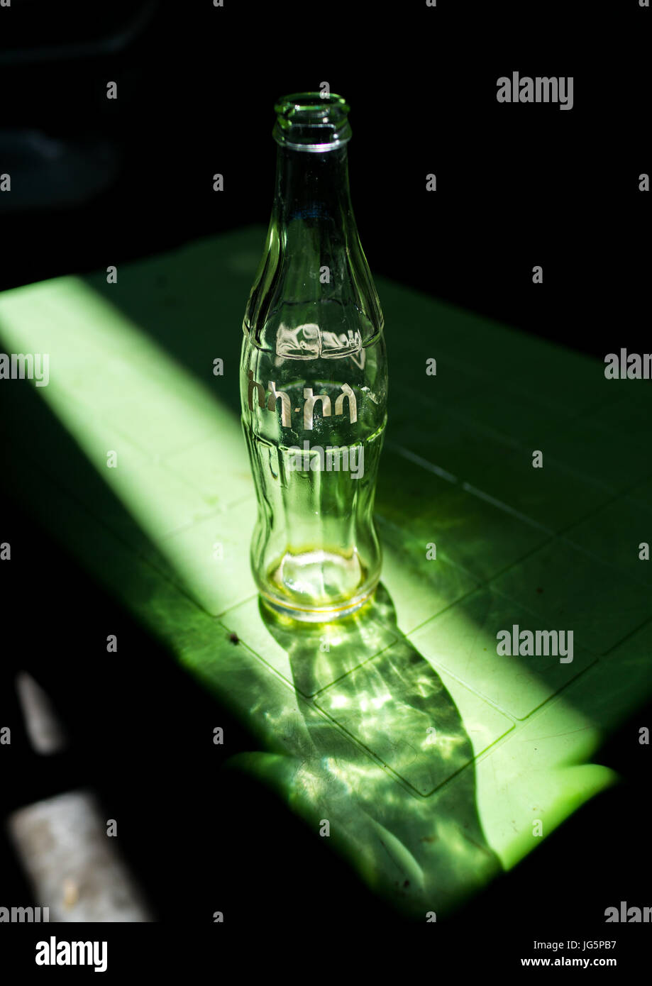 Ethiopian coca cola bottle in a ray of light in a bar, Omo Valley ...