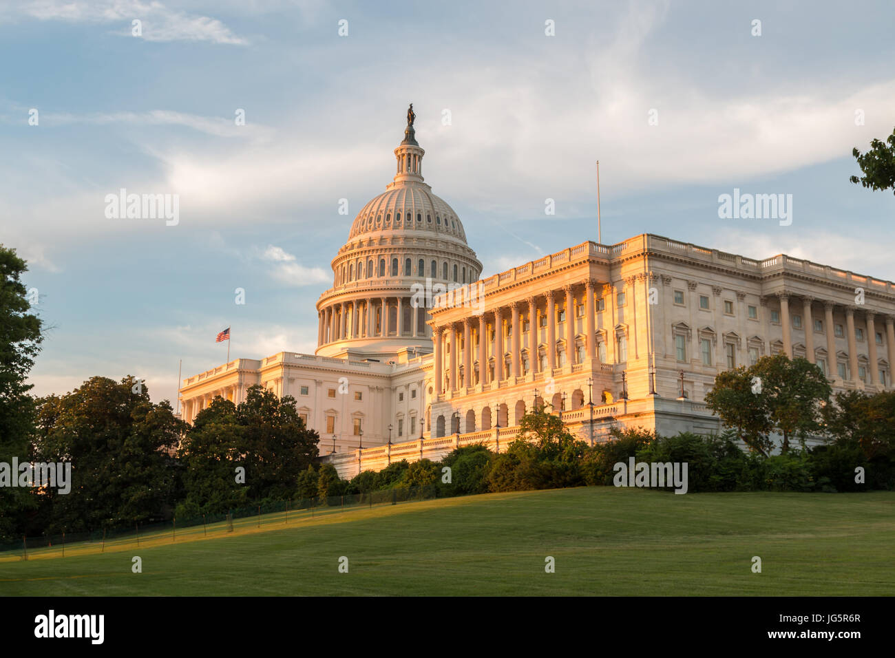 View of the US Capitol building at dusk with green grass Stock Photo ...
