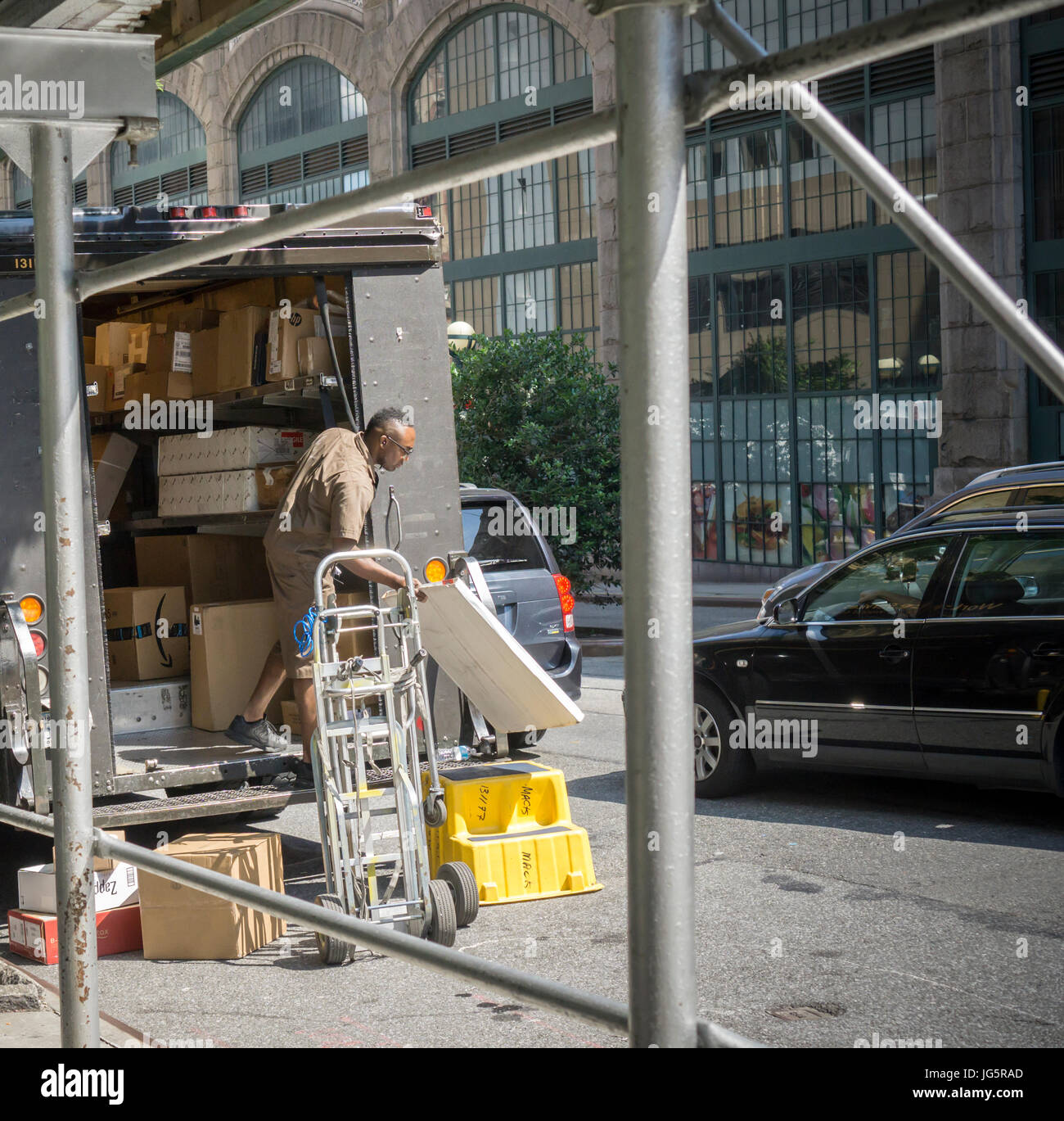 A UPS worker with his truck and deliveries in New York on Wednesday ...