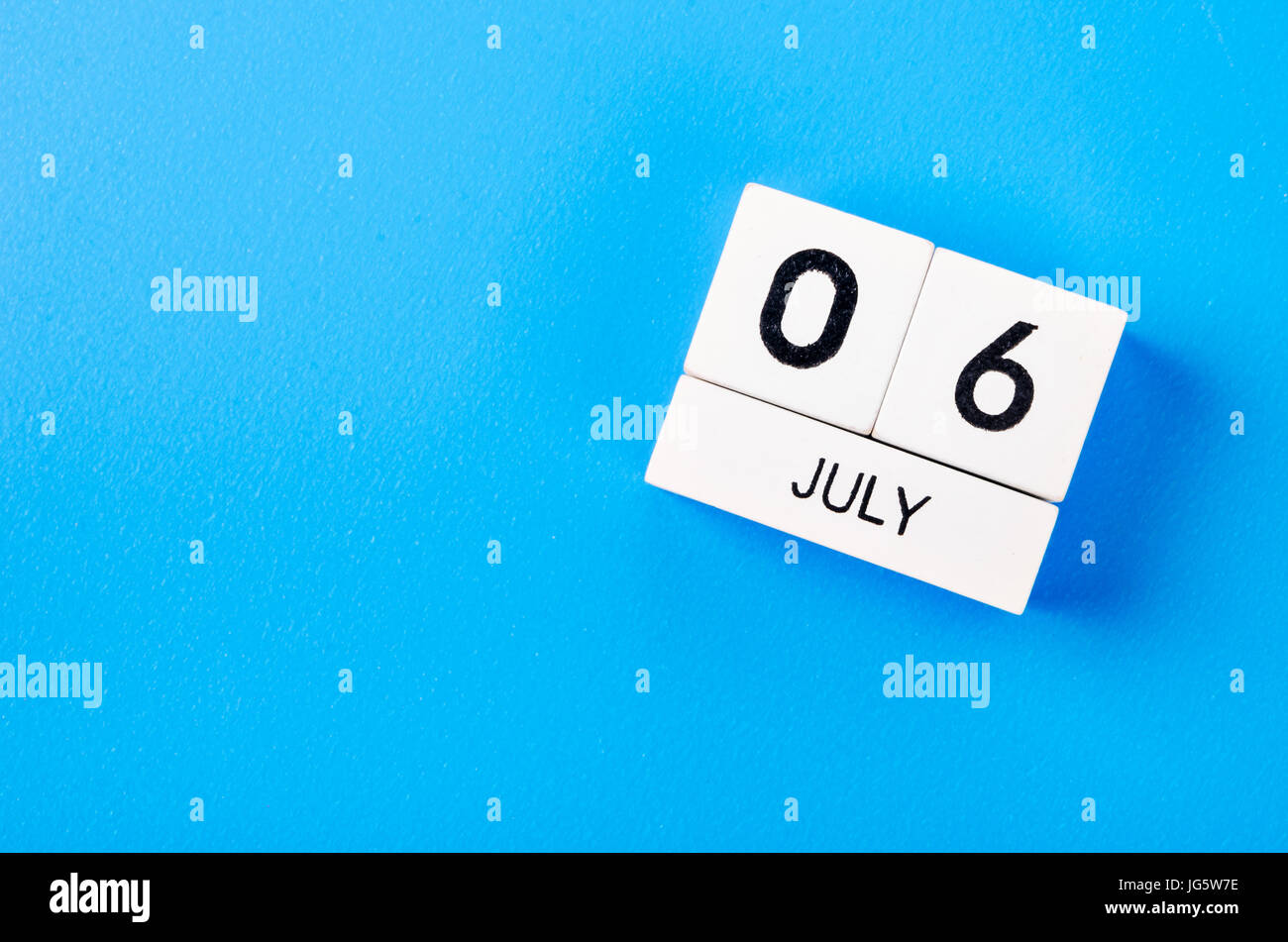 July 6th. Image of july 6 wooden color calendar on blue background ...