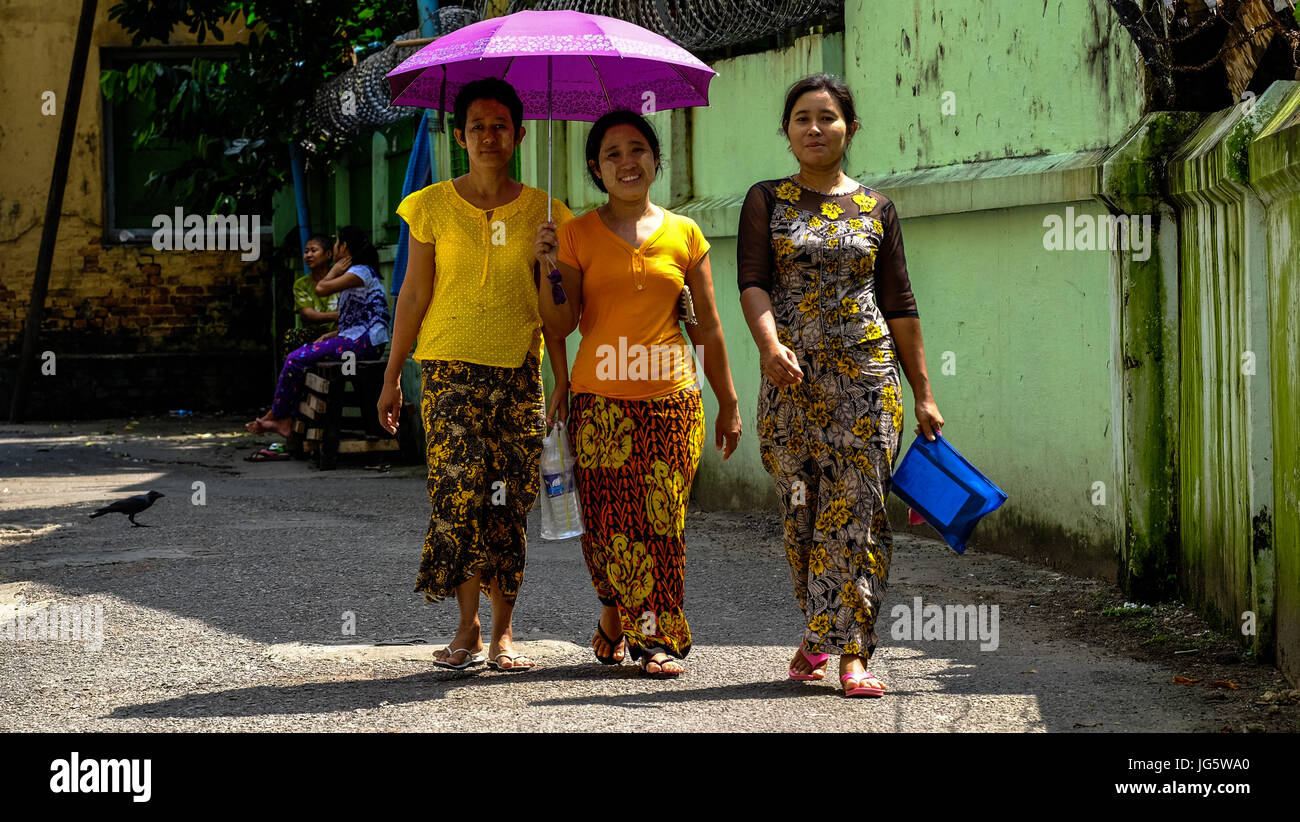 Three Burmese ladies walking down a Yangon street, Myanmar Stock Photo ...