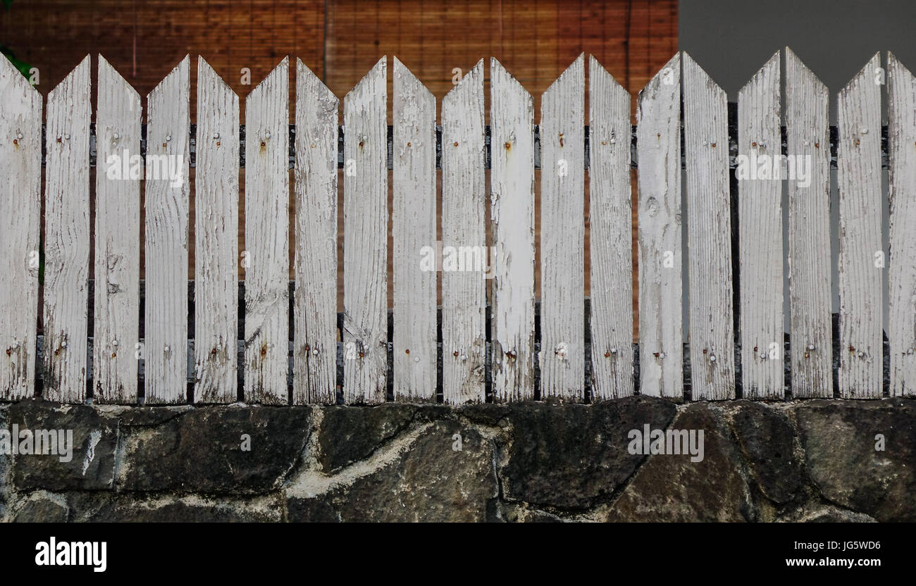 Wooden fence with stone wall at the ancient building in Grand Baie ...