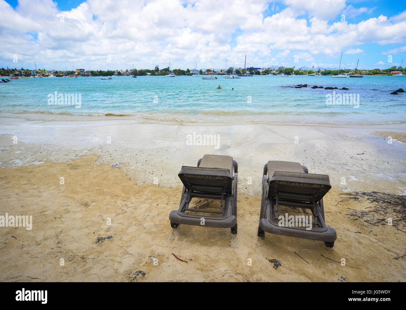 Relaxing chairs on the beach in Grand Baie, Mauritius. Mauritius, an ...