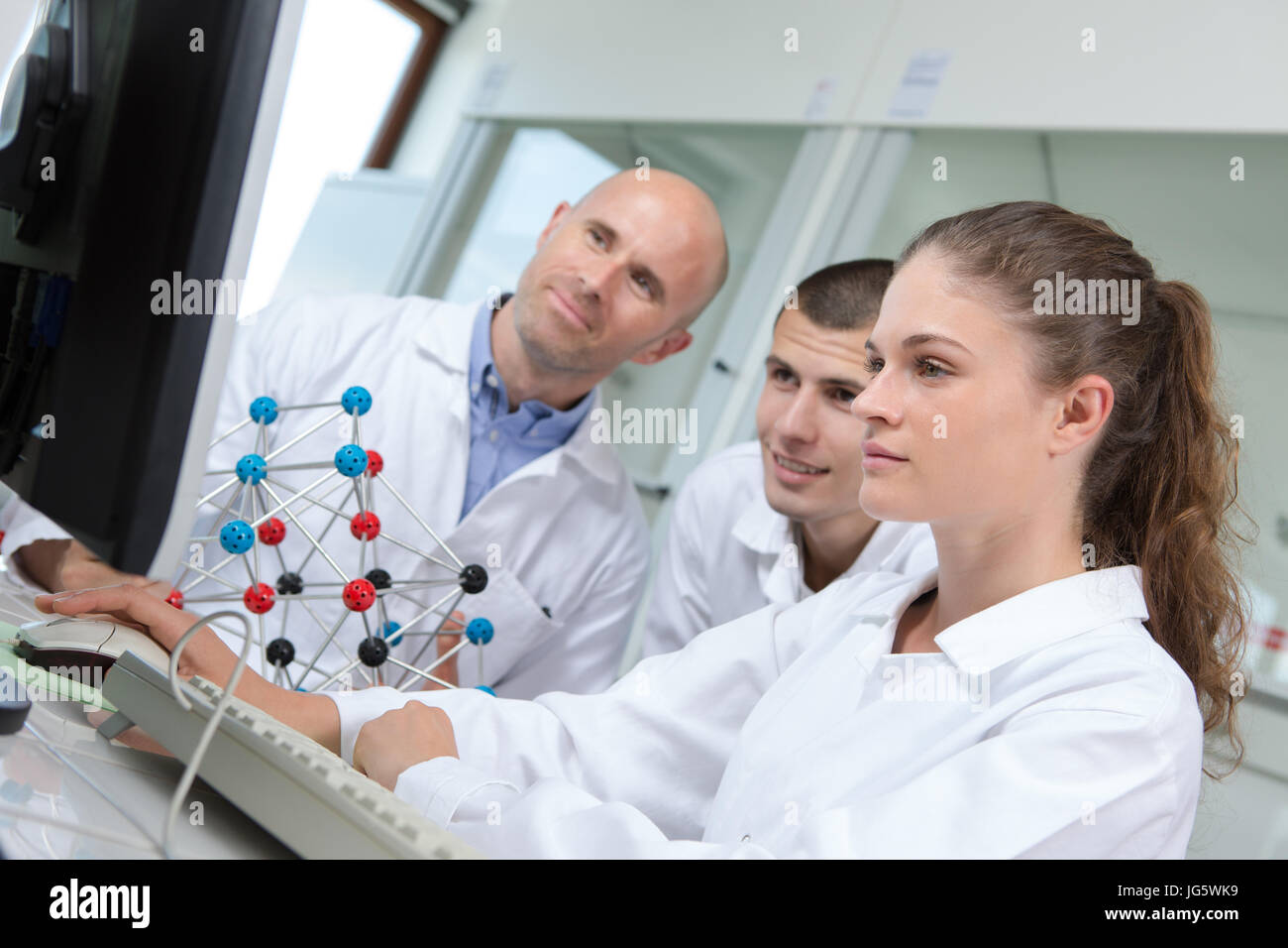 it lessons students with teacher working on pc Stock Photo - Alamy