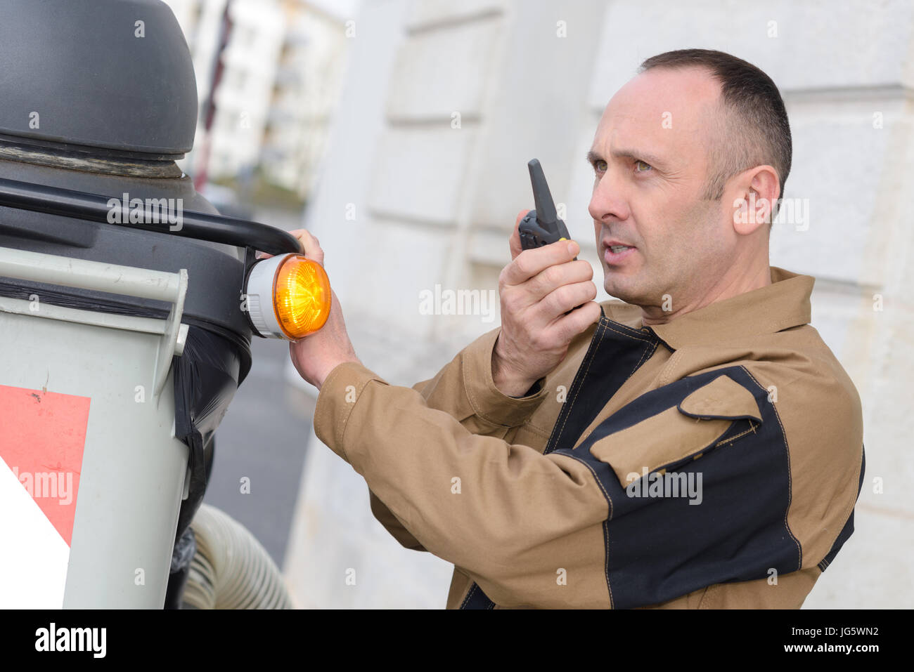 Worker using walkie talkie Stock Photo - Alamy