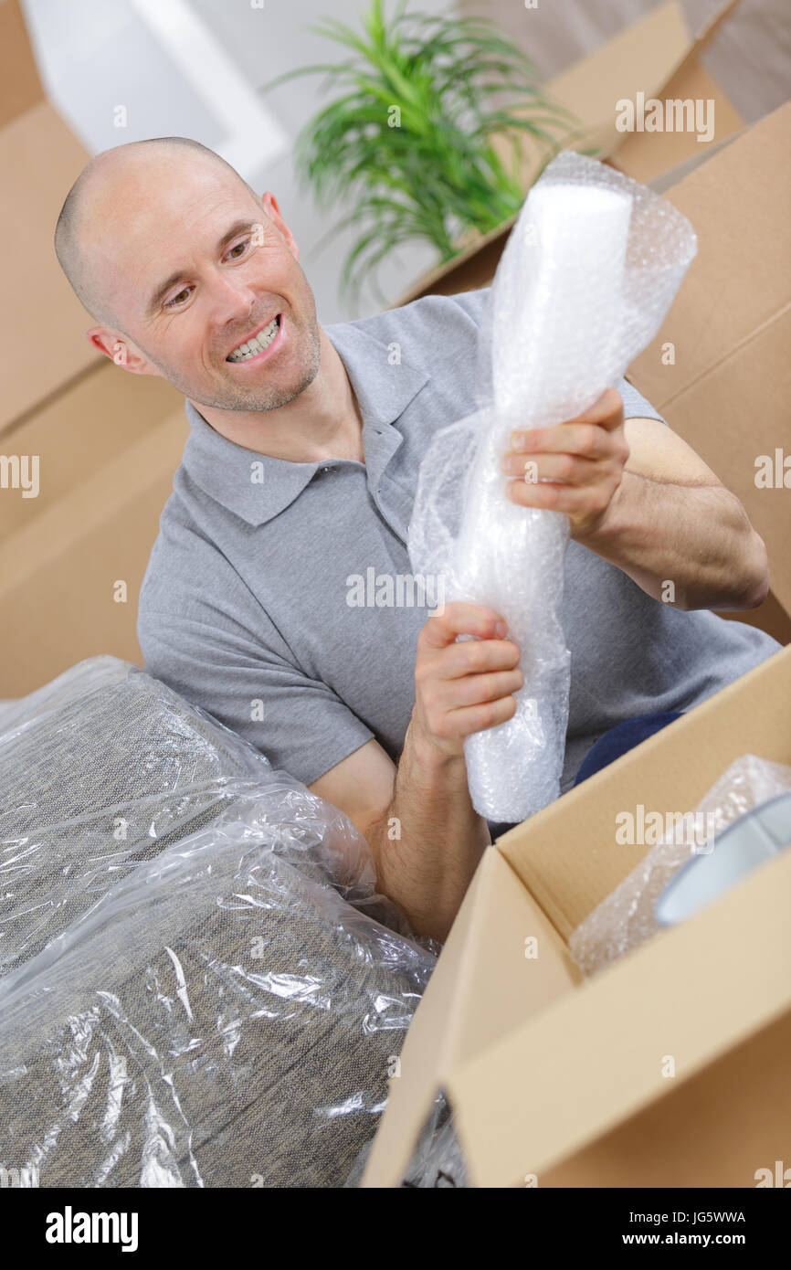 Young man opening box furniture hi-res stock photography and images - Alamy
