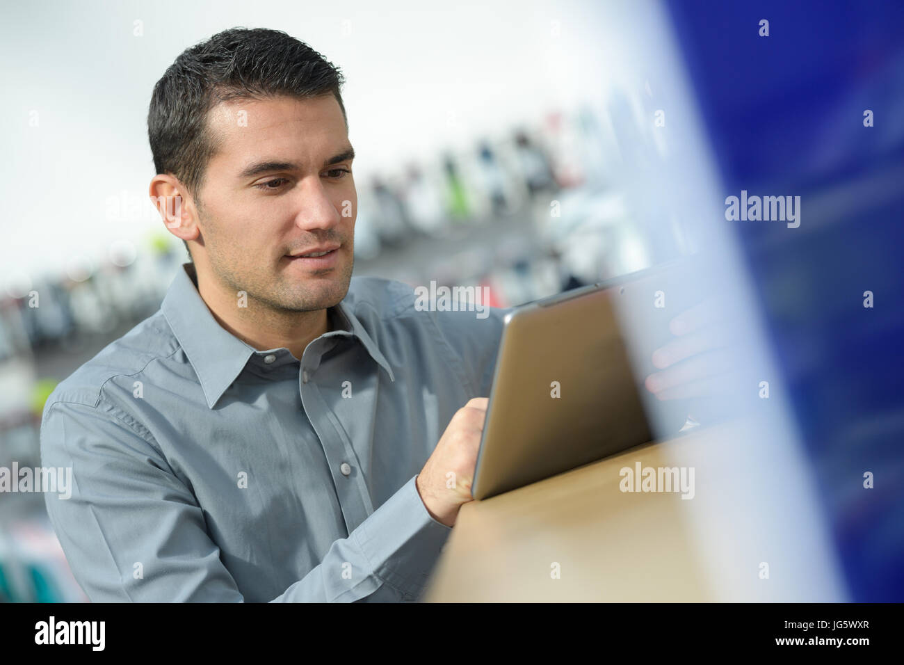 man holding tablet computer at hardware store Stock Photo - Alamy