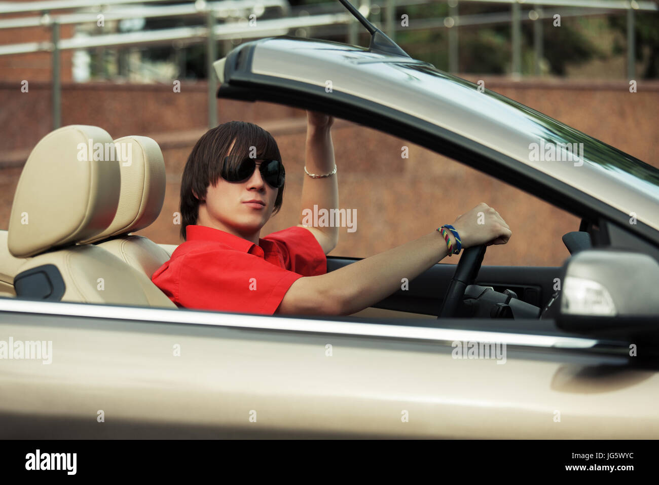 Cool guy driving convertible car hi-res stock photography and images ...