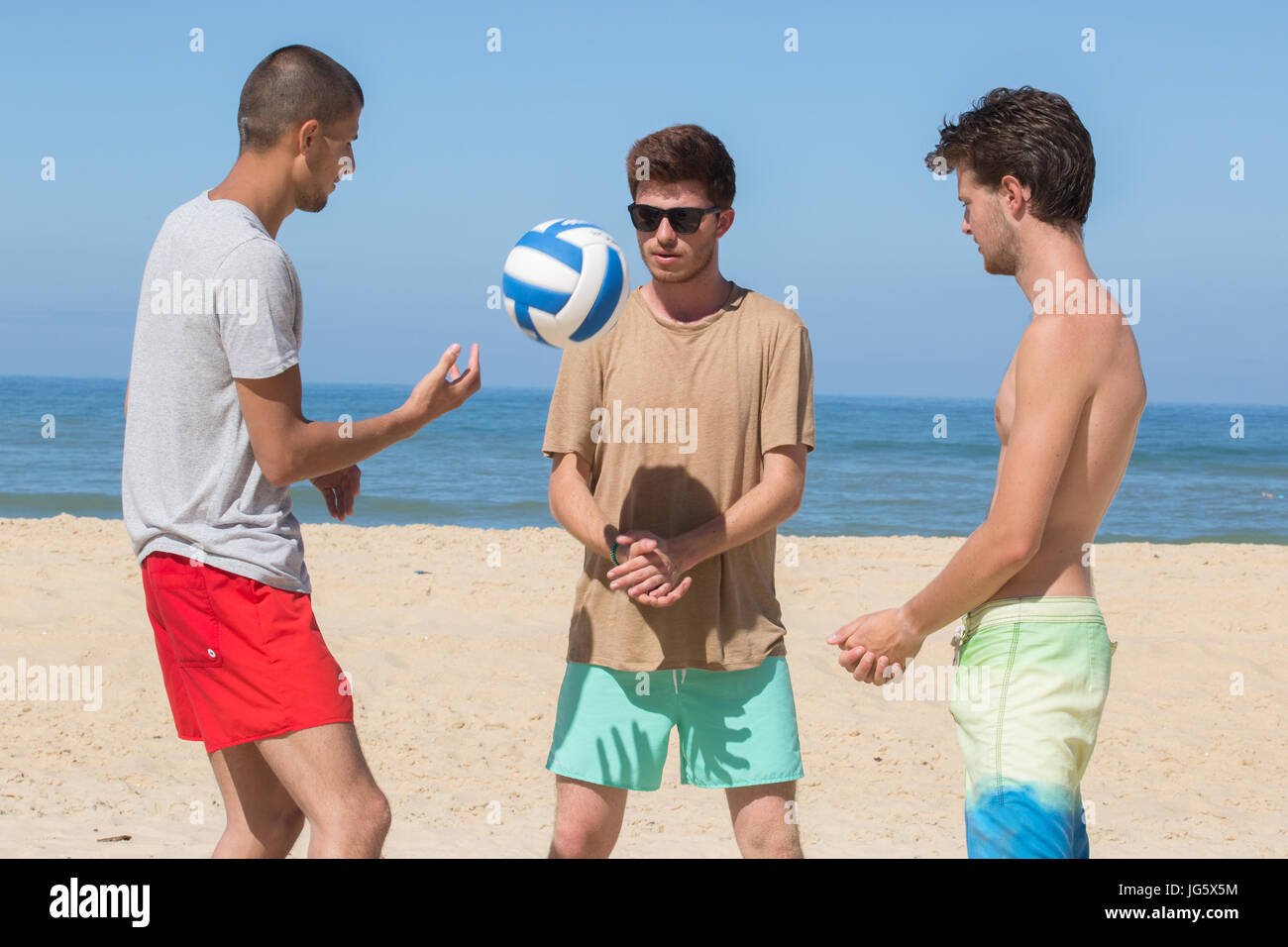 happy friends playing beach ball Stock Photo - Alamy