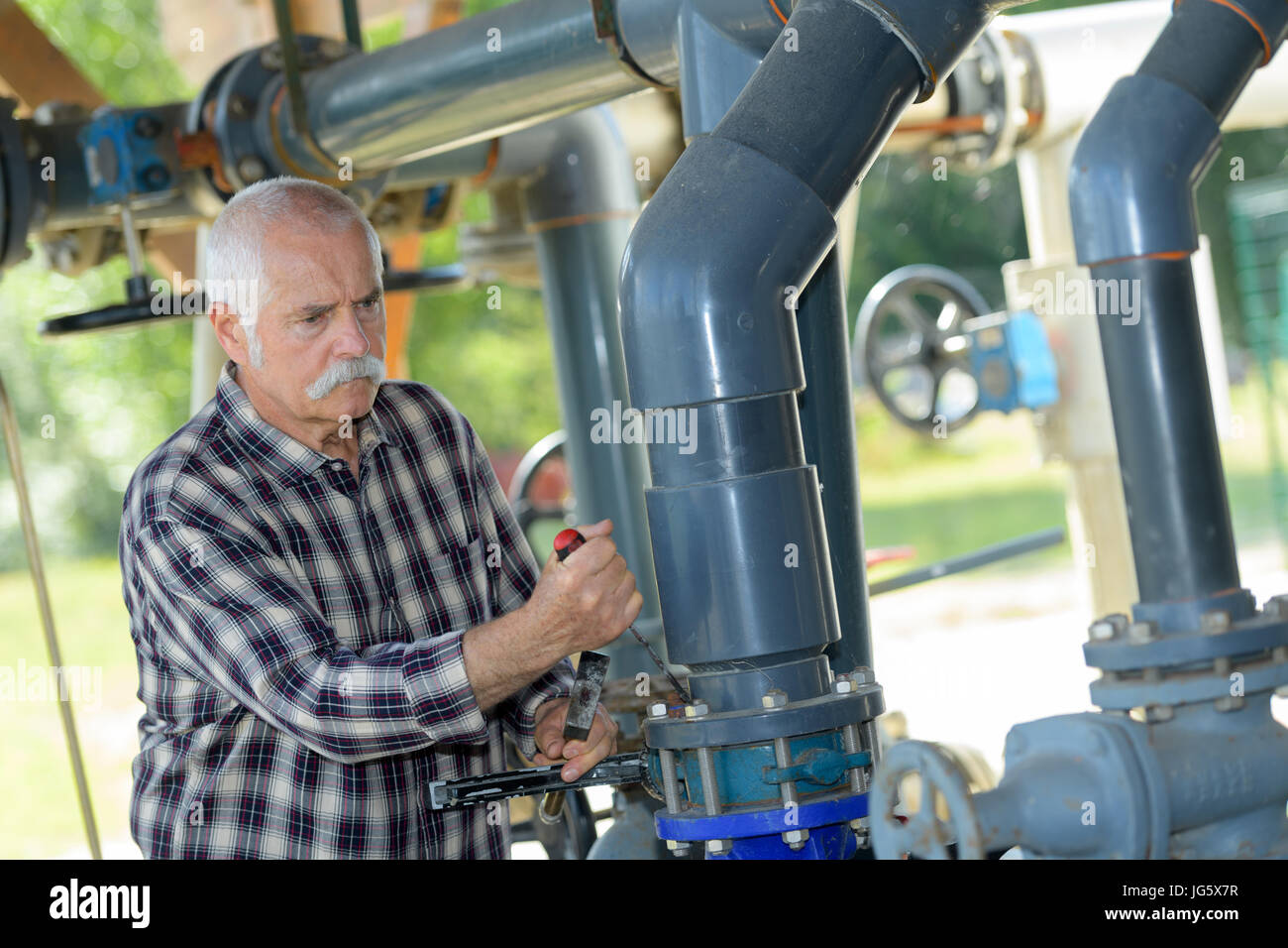 old man working at a water pvc pipe section Stock Photo - Alamy