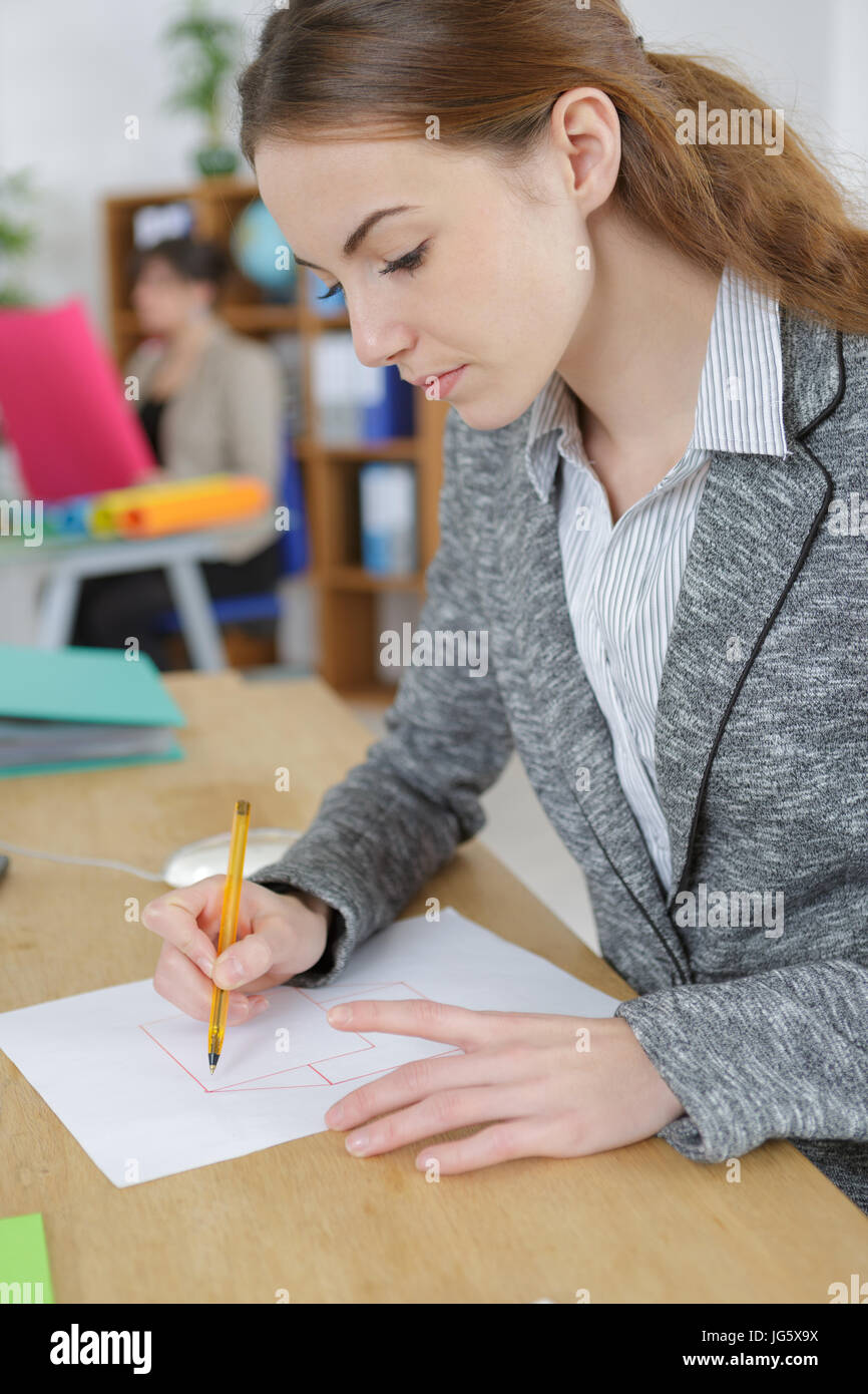 creative female with pen drawing on paper Stock Photo - Alamy