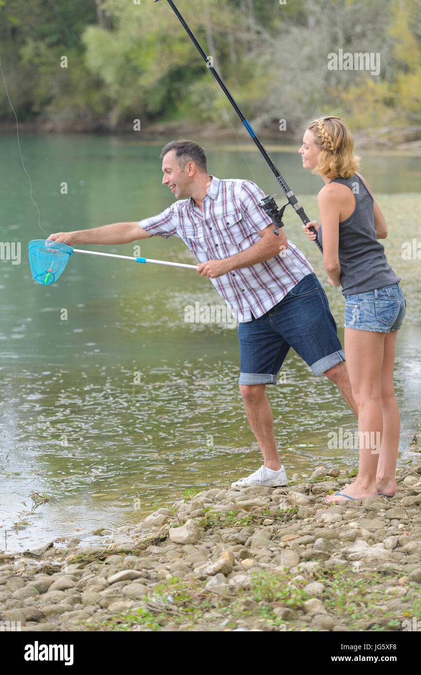 Couple catching fish hi-res stock photography and images - Alamy