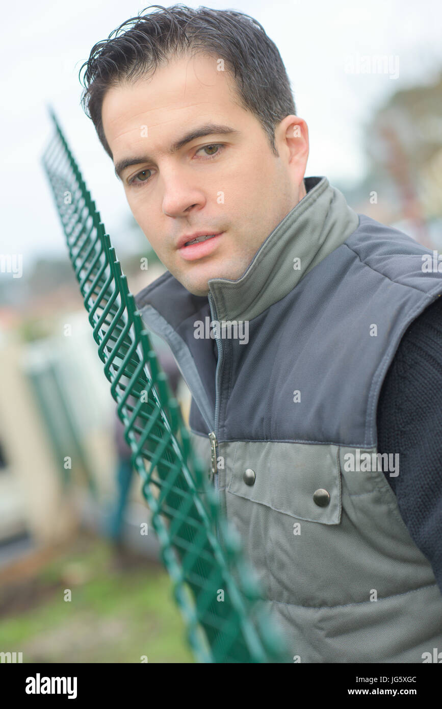 man building a fence Stock Photo - Alamy