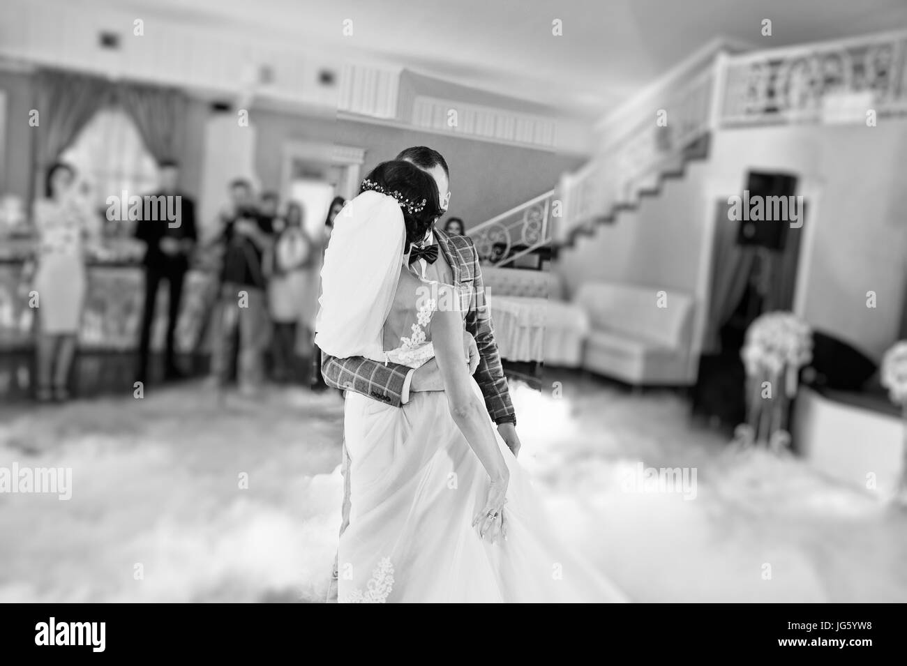 Beautiful wedding couple dancing their first dance in a restaurant with ...
