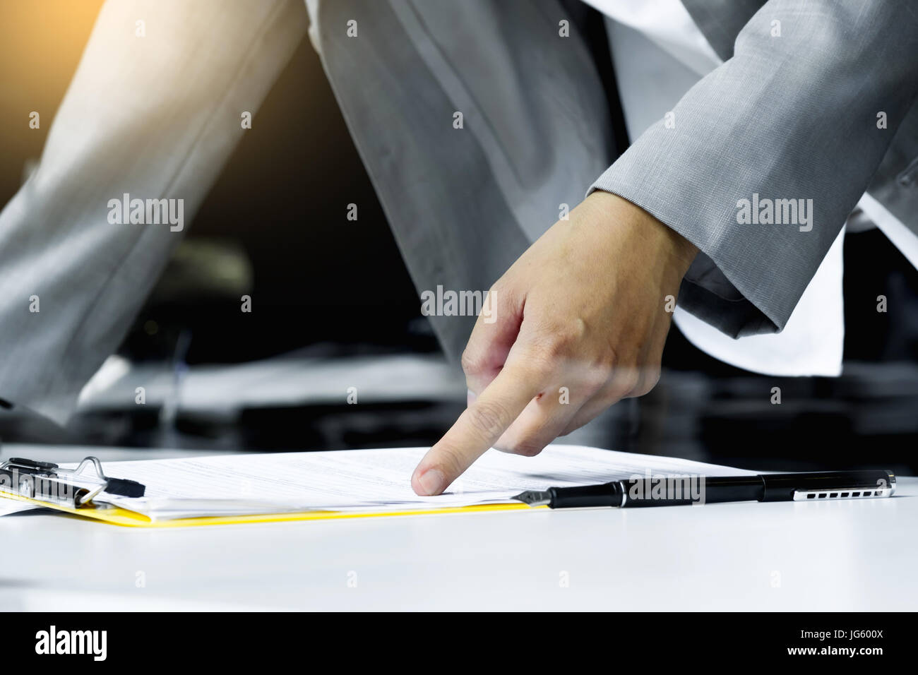 Close-up of human hand with pen pointing at paper while explaining ...
