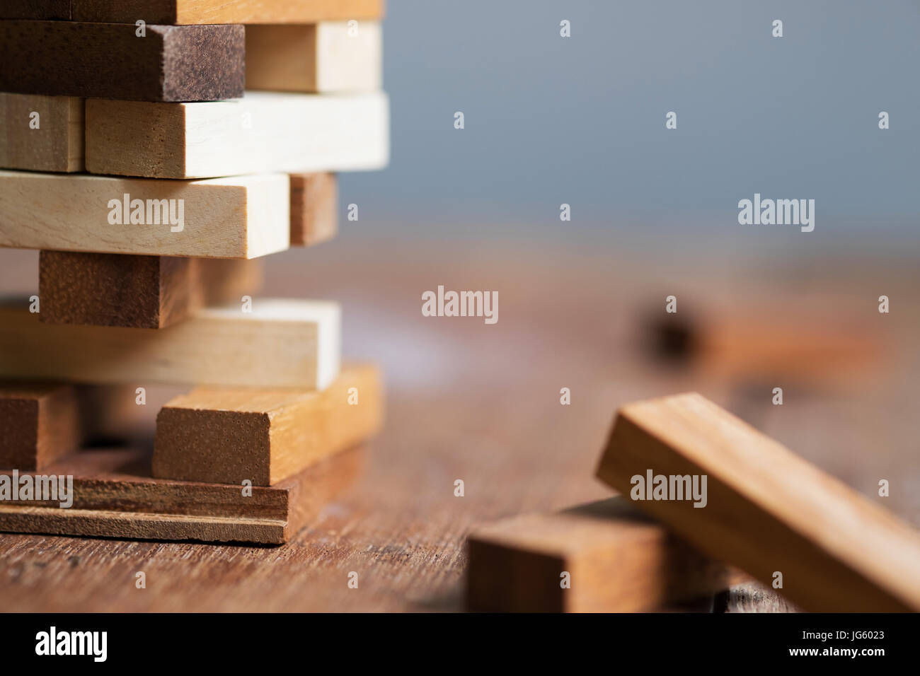 Blank wooden block leaning on a structure made of many other blocks ...
