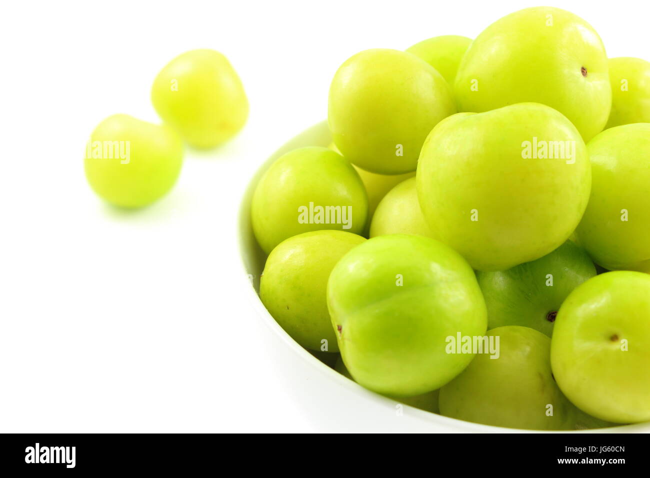 composition of fresh turkish can erik plum fruits in a small white bowl ...
