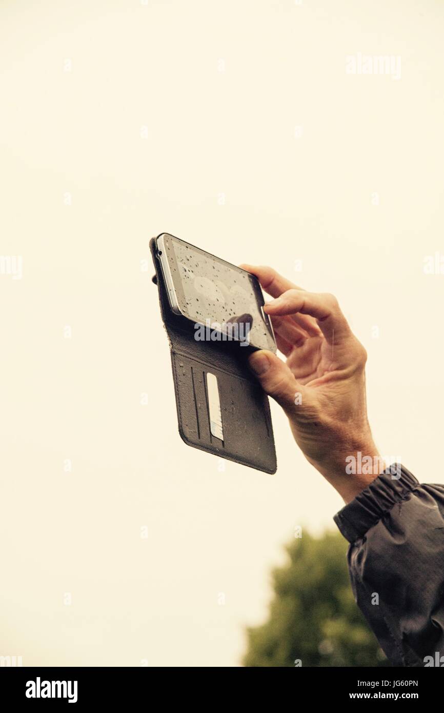 Hand holding phone up hi-res stock photography and images - Alamy