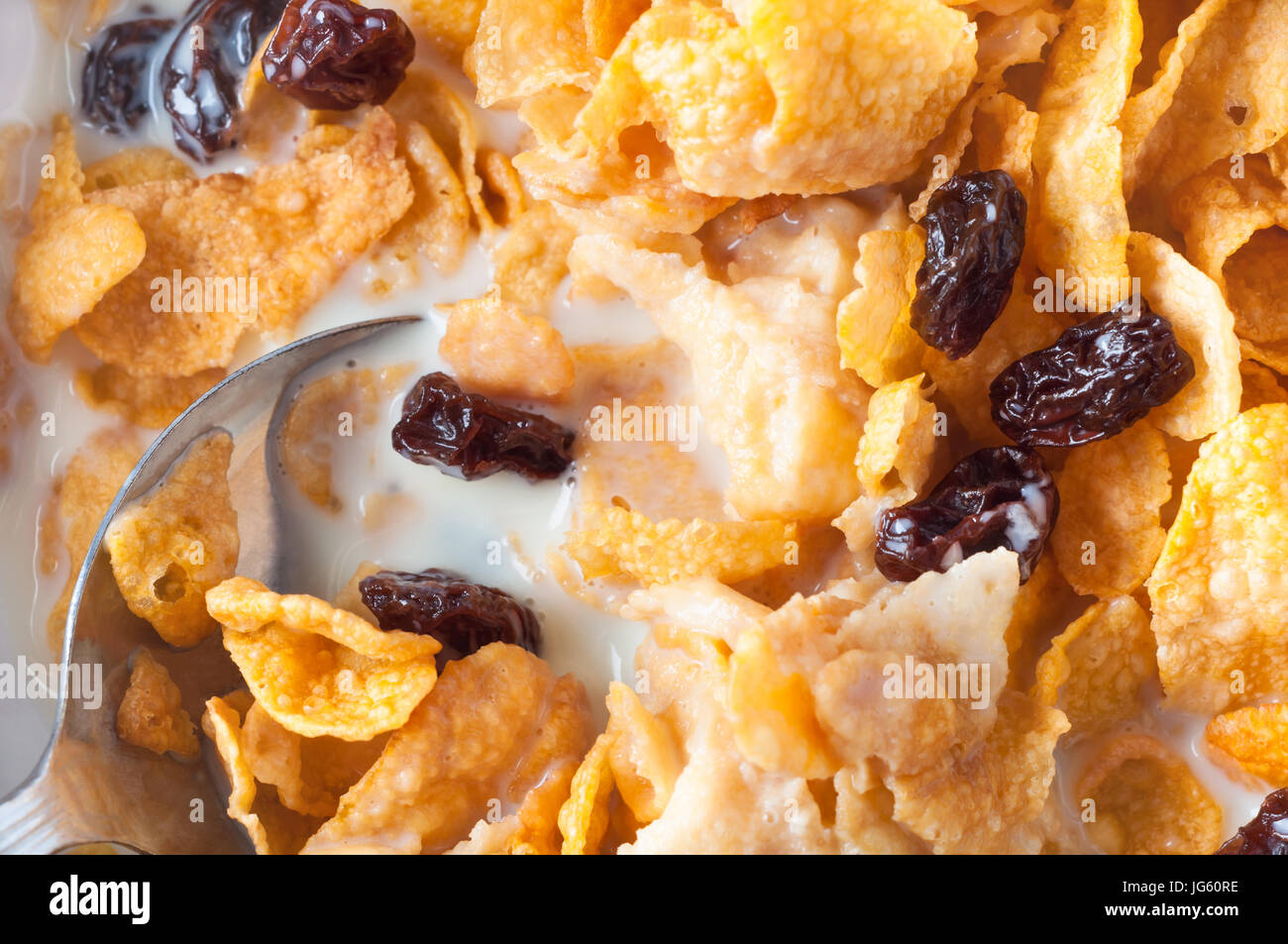 Close up, overhead and shot of cornflakes and raisins cereal breakfast ...