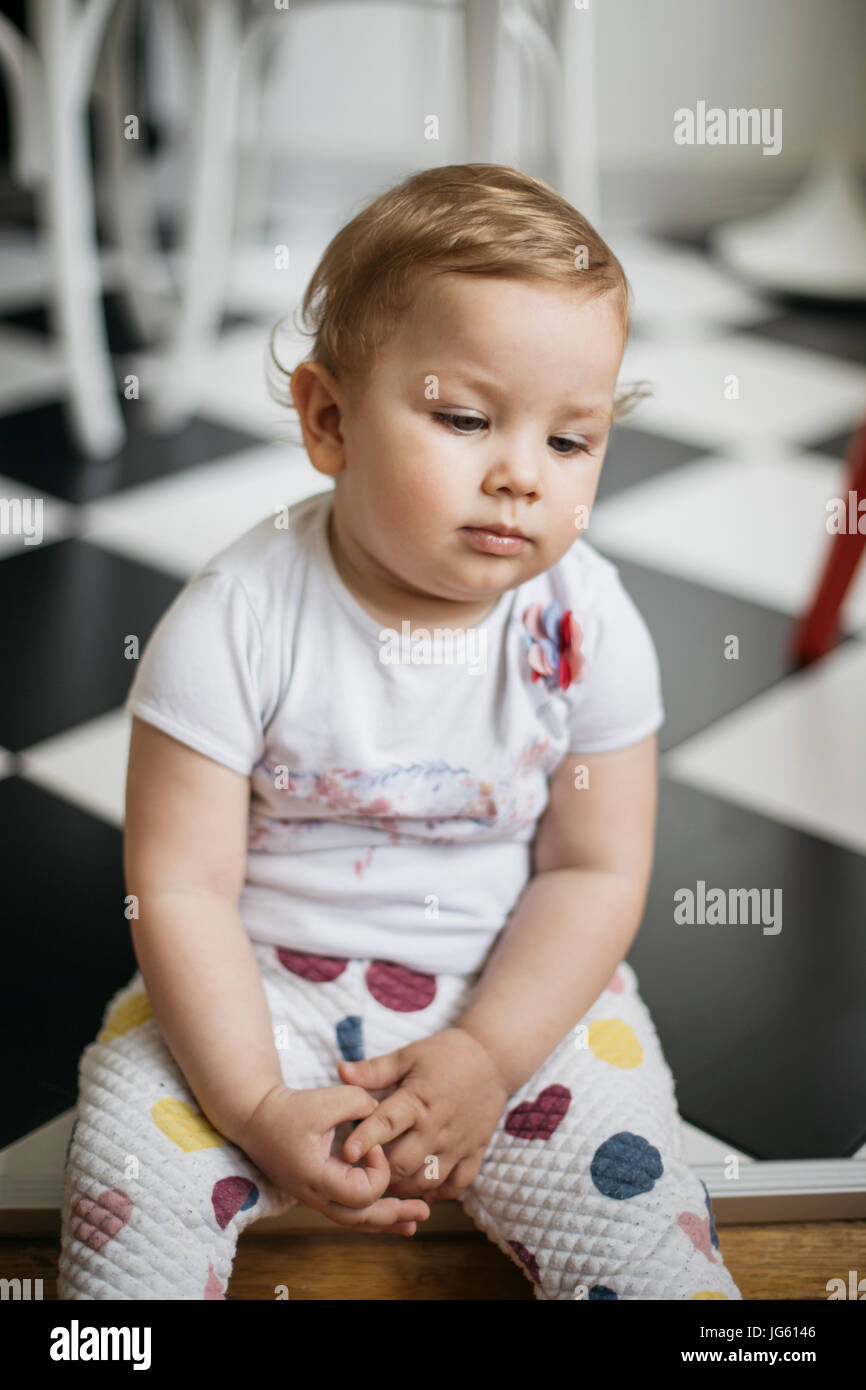 View at cute little girl on the floor in the room Stock Photo - Alamy