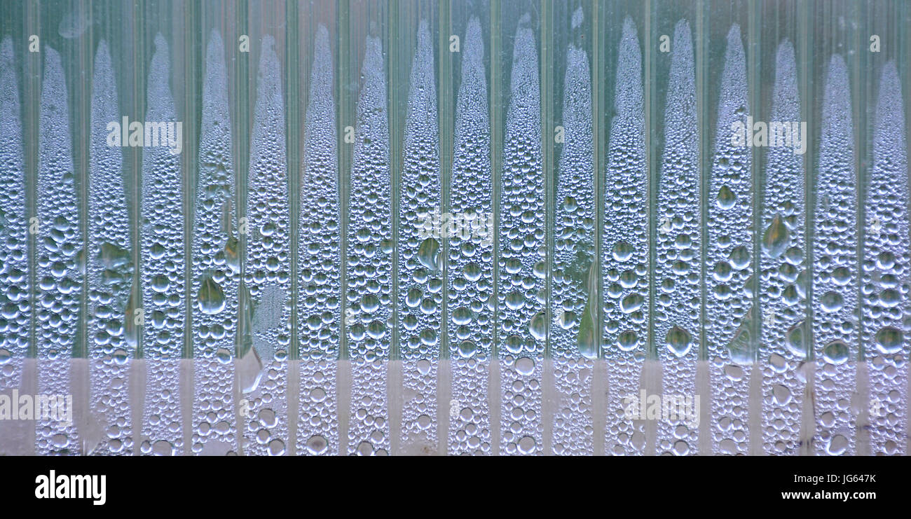Beautiful texture of misted glass, divided into sections and drops of ...