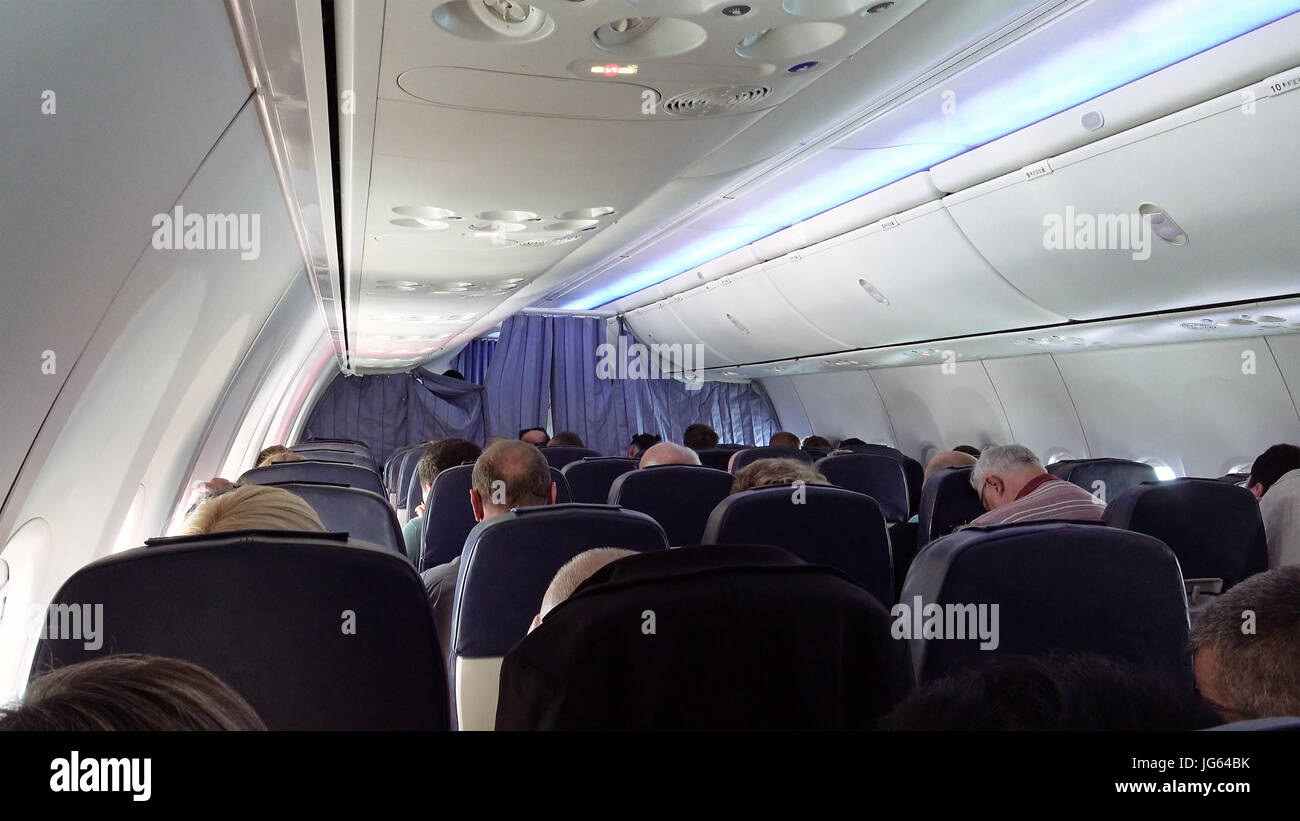 Passengers in airplane aircraft jet seats Stock Photo - Alamy
