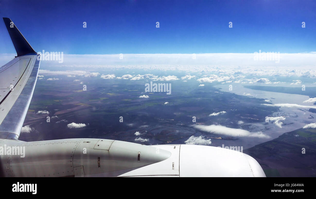 Flying over the clouds in a plane aircraft Stock Photo - Alamy