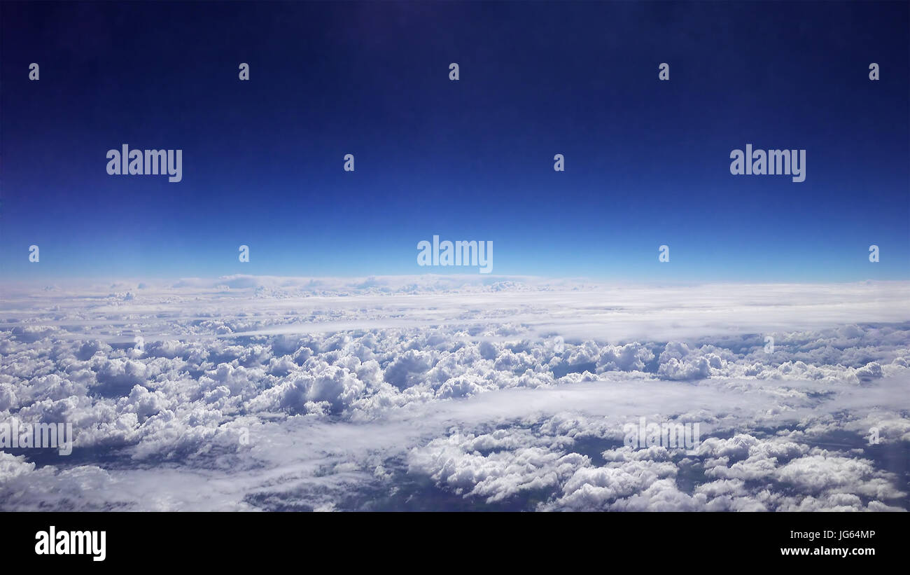 Flying over the clouds. Clouds and skyline view Stock Photo - Alamy