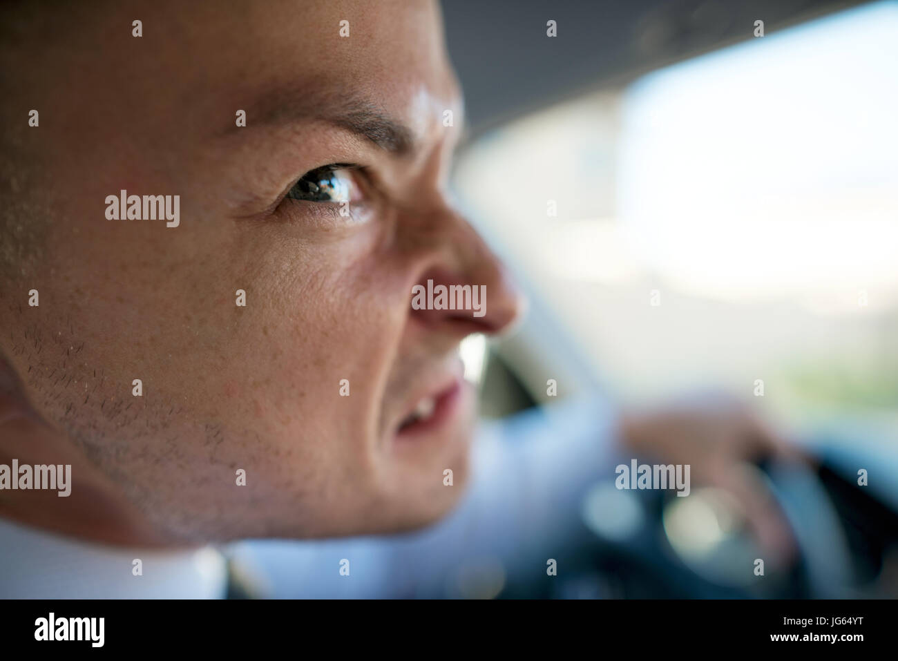 man behind the wheel of a car on the road Stock Photo - Alamy