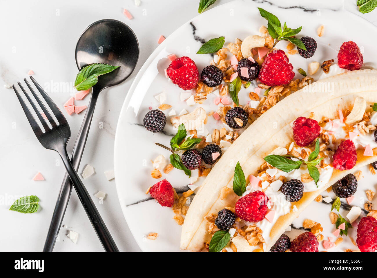 Summer fruit berry breakfast. Healthy banana split breakfast with cream ...