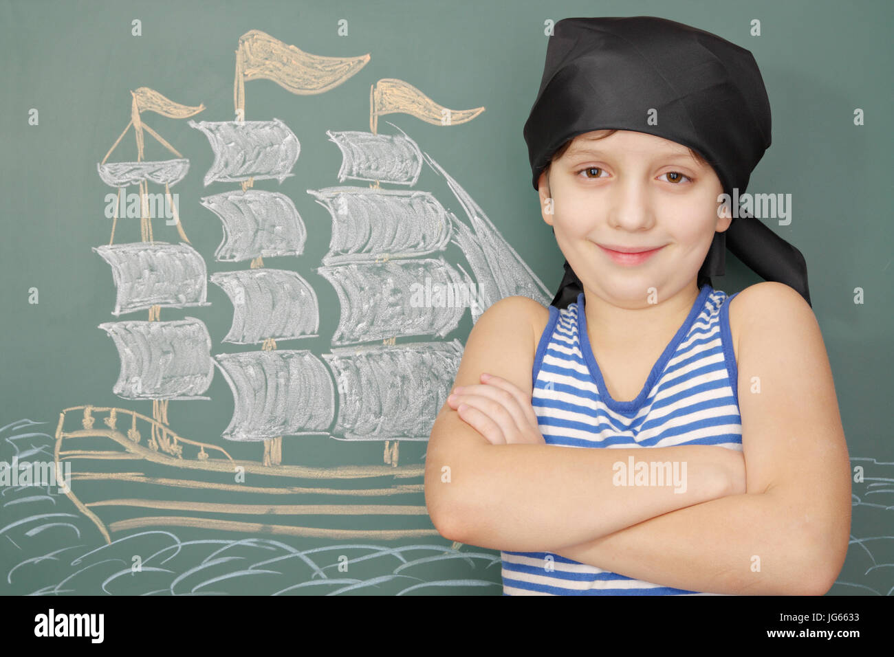 Laughing boy pirate on background of ship Stock Photo - Alamy